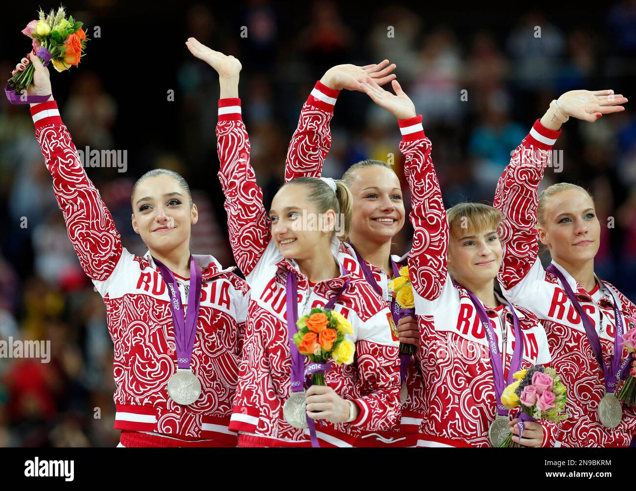Russian gymnasts, left to right, Aliya Mustafina, Victoria Komova ...