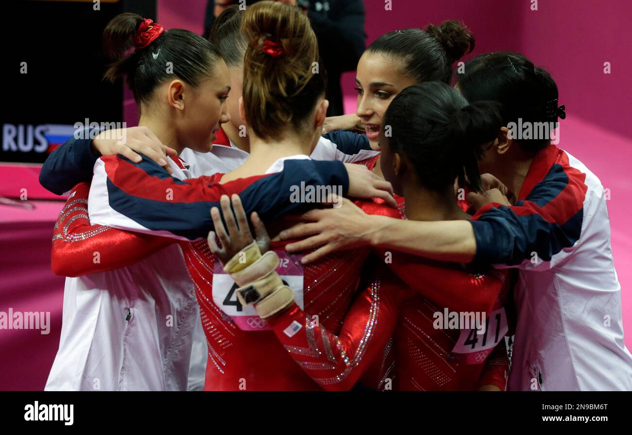 U.S. gymnasts huddle together after their performance during the ...