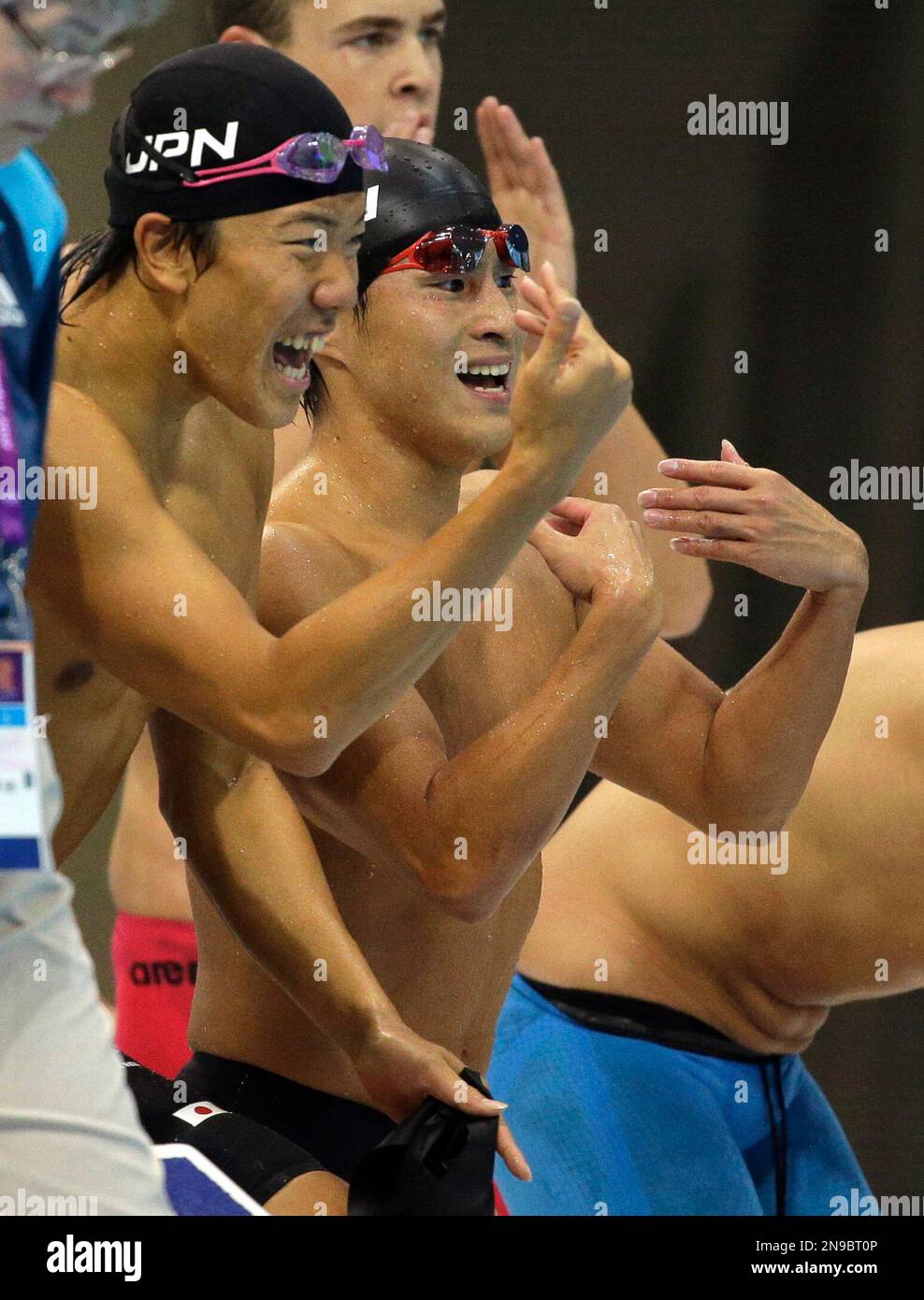 Japanese swimmers cheer their team members during a men's 4x200-meter ...