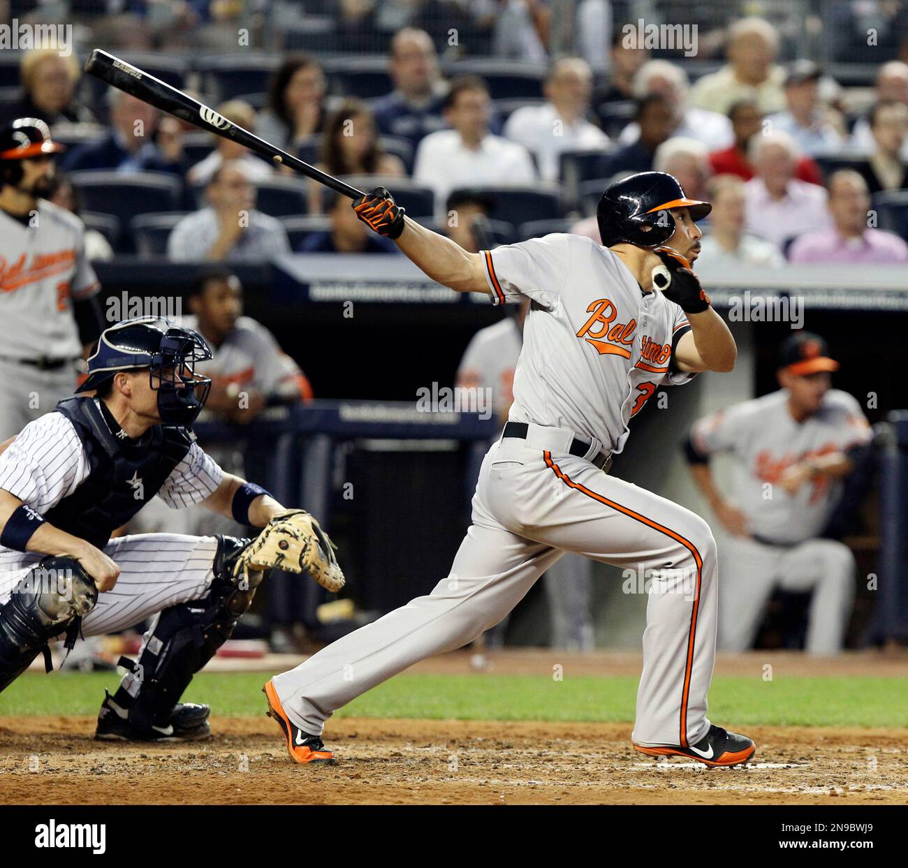 Baltimore Orioles' Omar Quintanilla hits a sacrifice fly to score a run ...