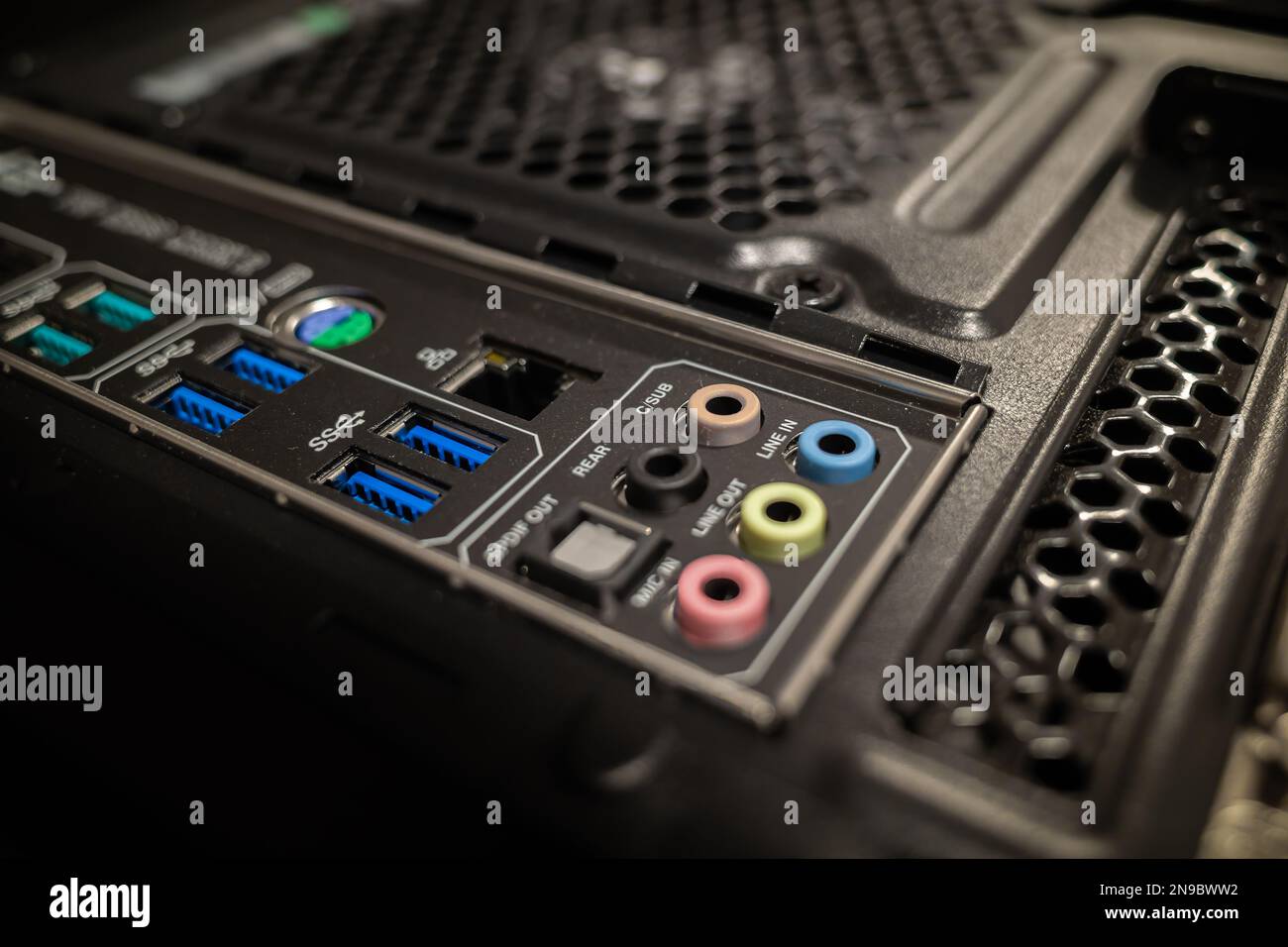 The back of the desktop computer with various inputs, USB sockets, fan ...