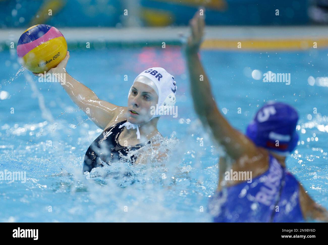 Fiona McCann of Britain, left, attempts a shot on goal as Alexandra ...