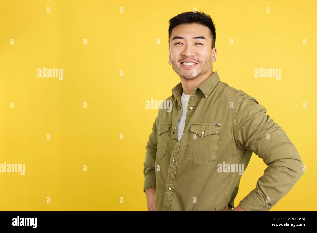 Handsome chinese man standing smiling at the camera Stock Photo - Alamy