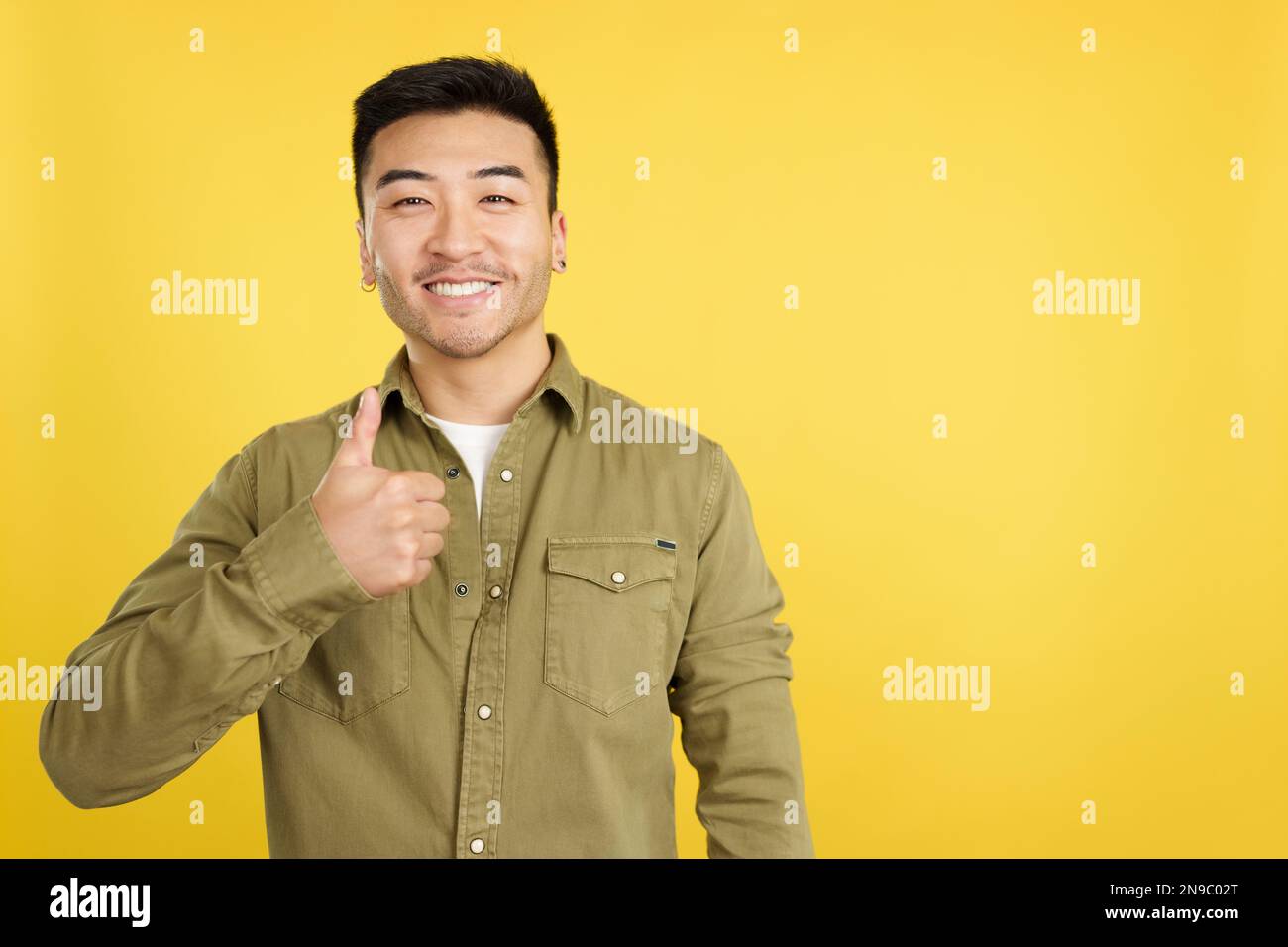 Happy chinese man gesturing agreement raising a thumb up Stock Photo ...