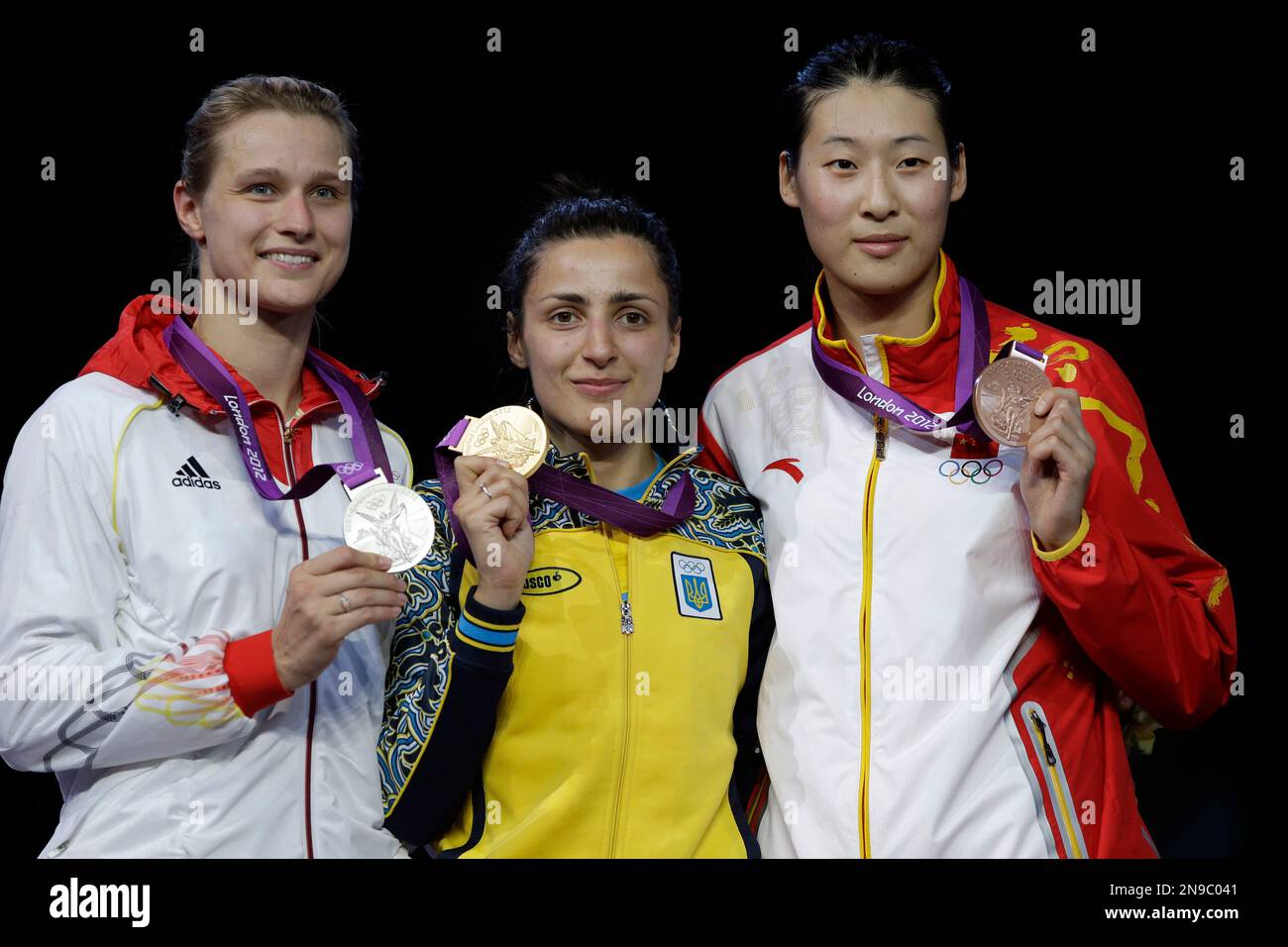 Gold medalist Ukraine's Yana Shemyakina is flanked by silver medalist ...