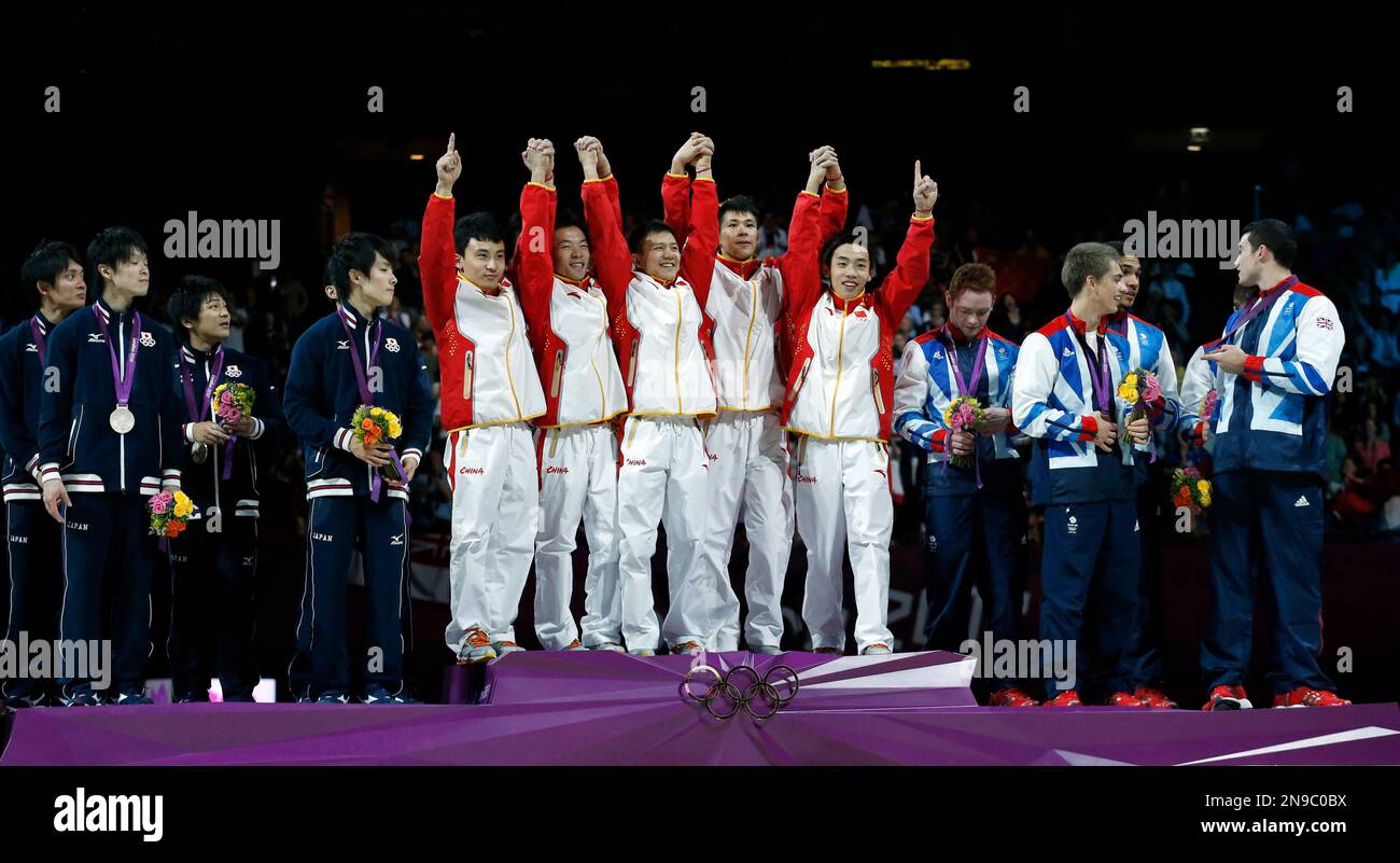Chinese gymnasts, left to right, Feng Zhe, Guo Weiyang, Chen Yibing ...