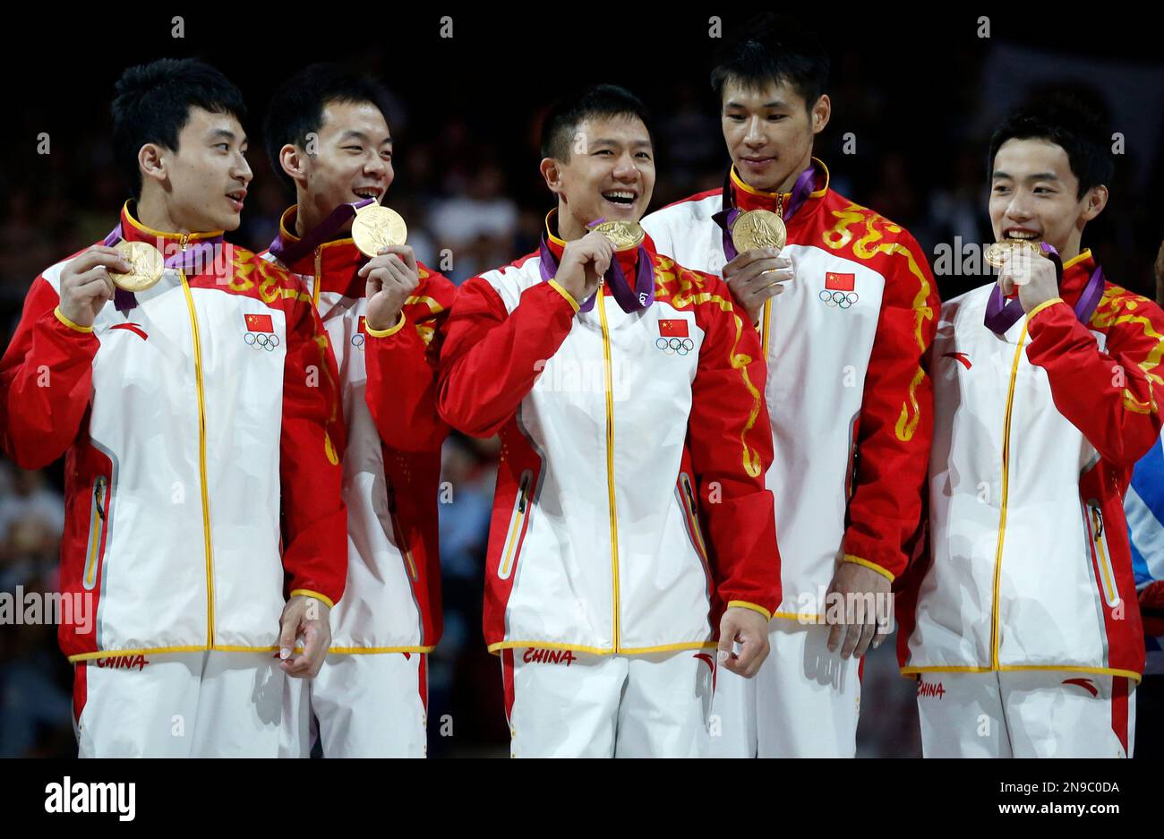Chinese gymnasts, left to right, Feng Zhe, Guo Weiyang, Chen Yibing ...