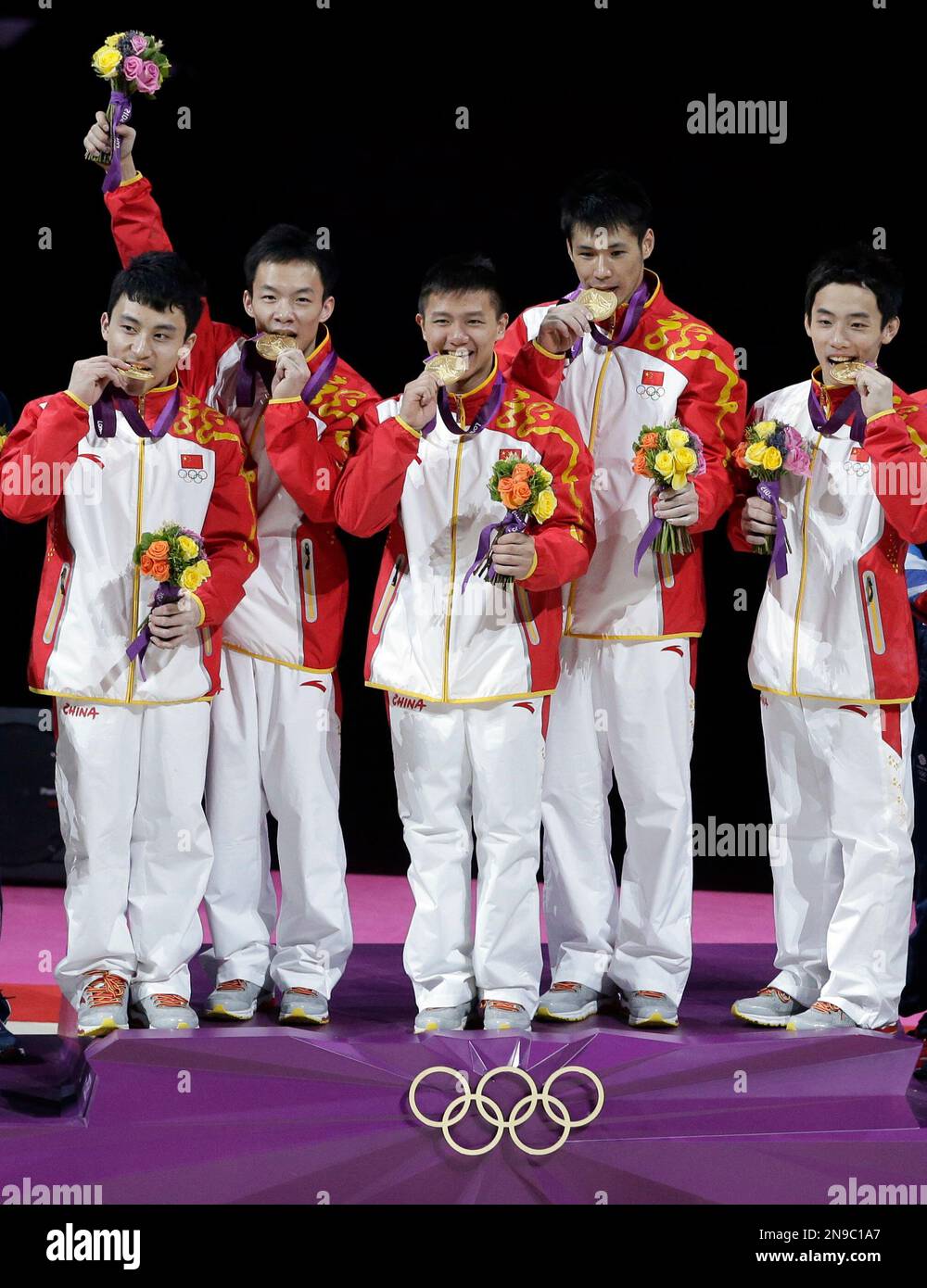 Chinese gymnasts, left to right, Feng Zhe, Guo Weiyang, Chen Yibing ...