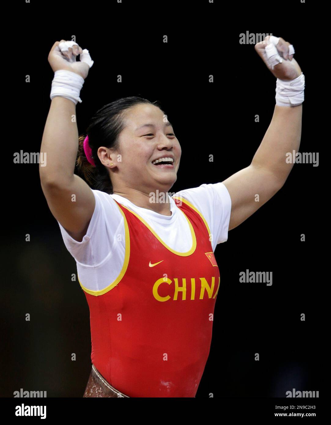 Xueying Li of China reacts after winning the gold medal in the women's 58-kg weightlifting ...