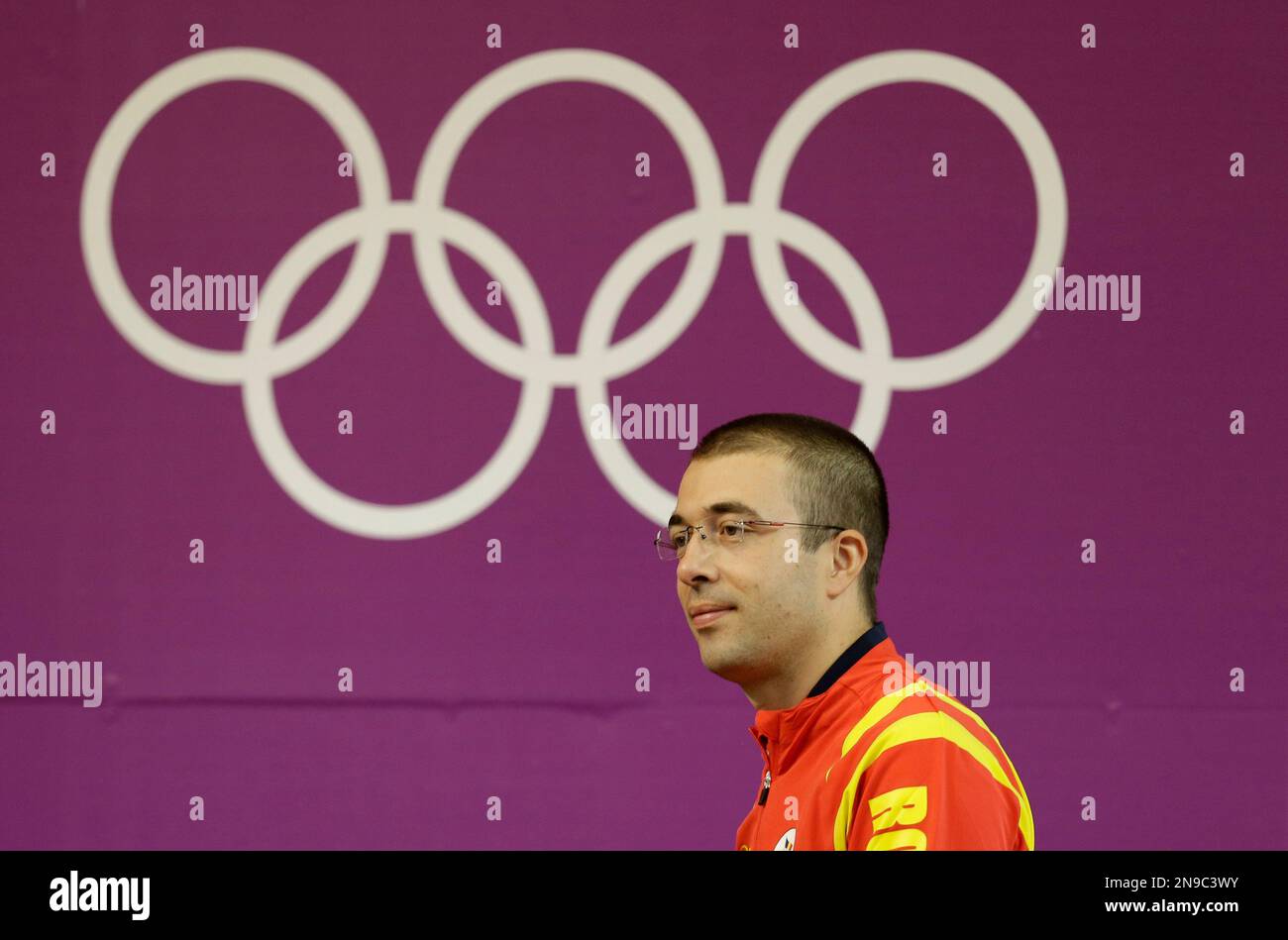 Romania's Alin George Moldoveanu walks past the Olympic rings logo as ...