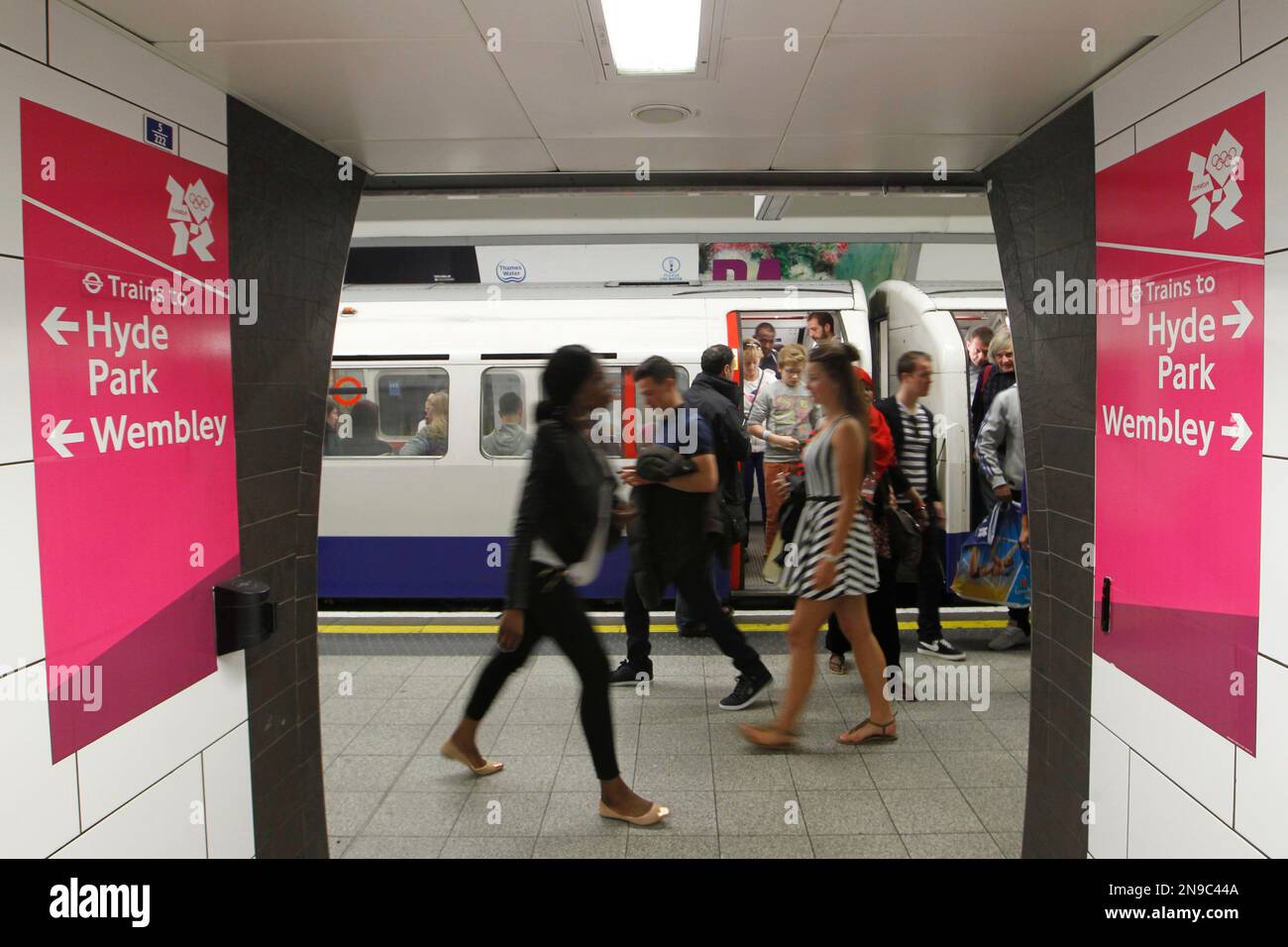Passengers disembark from a train at an underground station in central ...