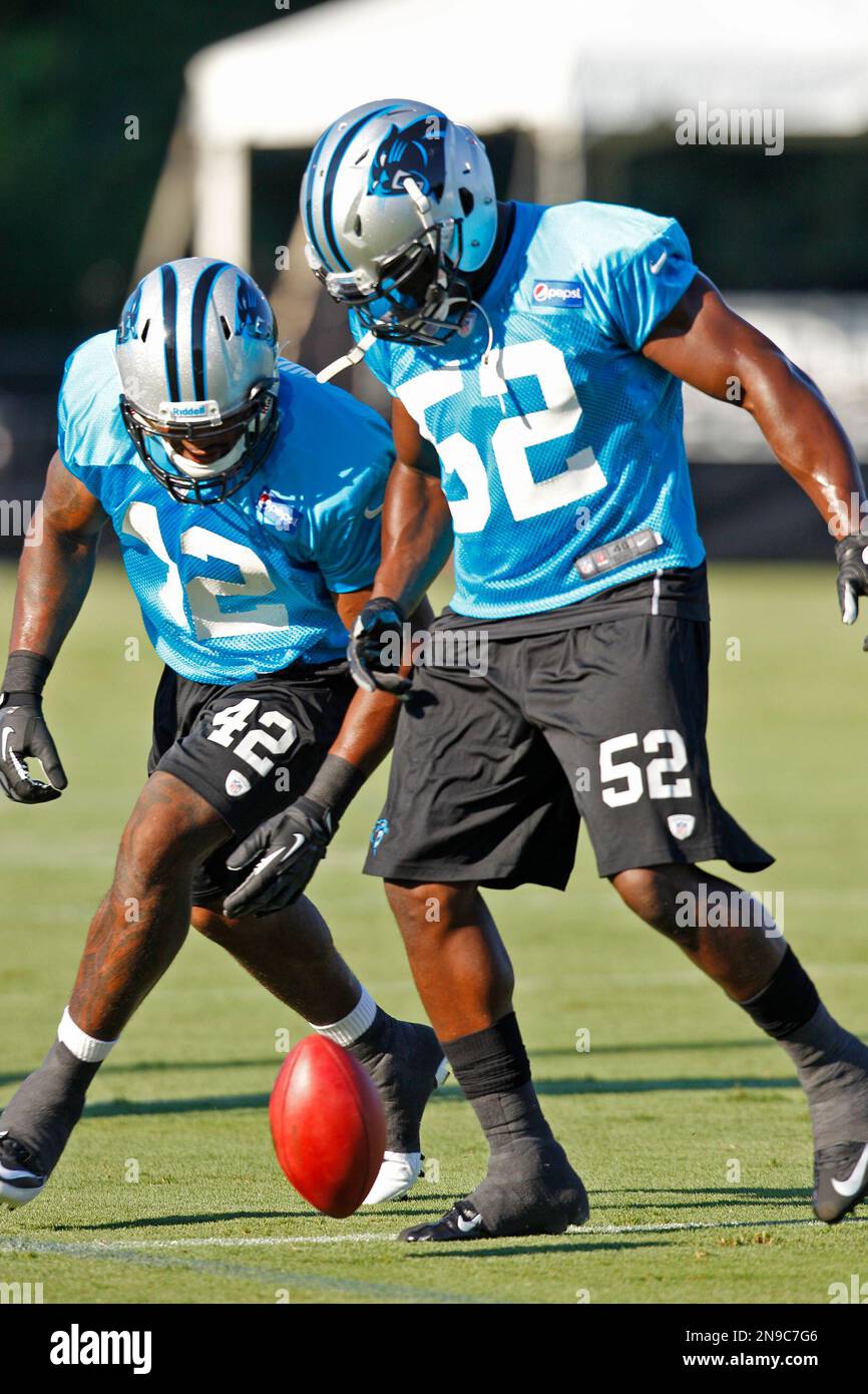 Carolina Panthers' Jon Beason (52) and Kion Wilson (42) chase a fumble ...