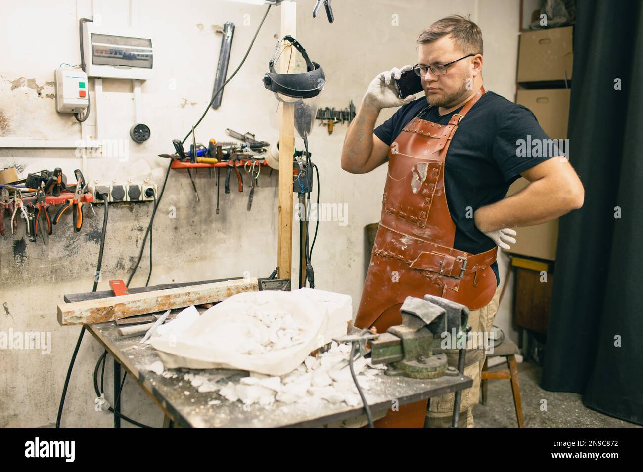 Man sculptor creates sculpt bust clay human woman sculpture and calling ...