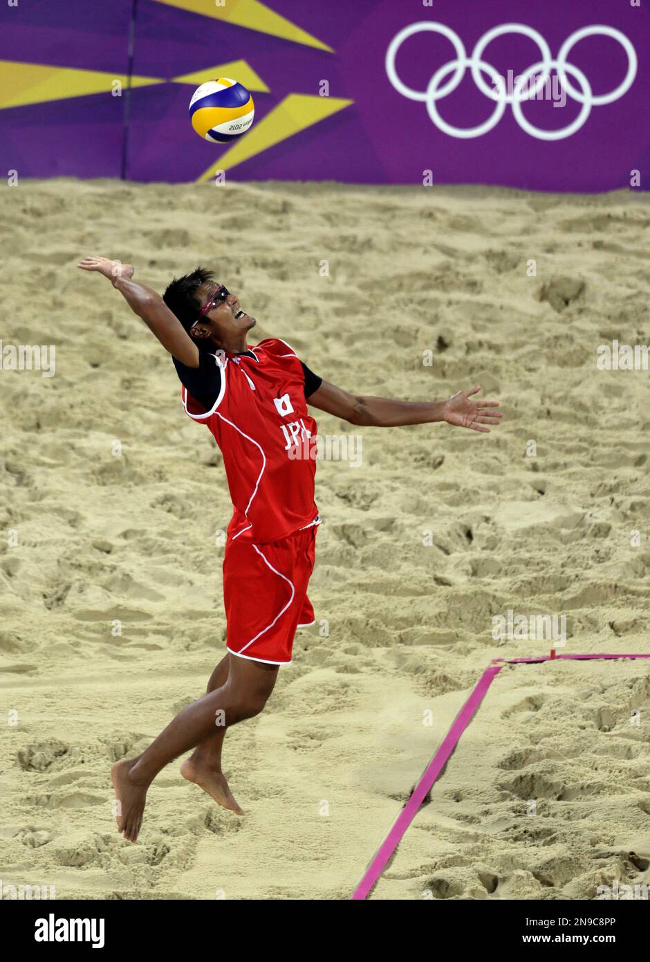 Kentaro Asahi of Japan serves to the United States during a beach ...