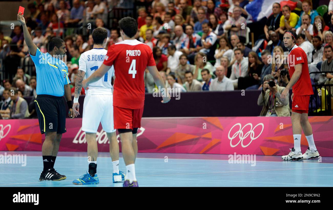 The referee shows the red card to Steven Larsson of Great Britain ...