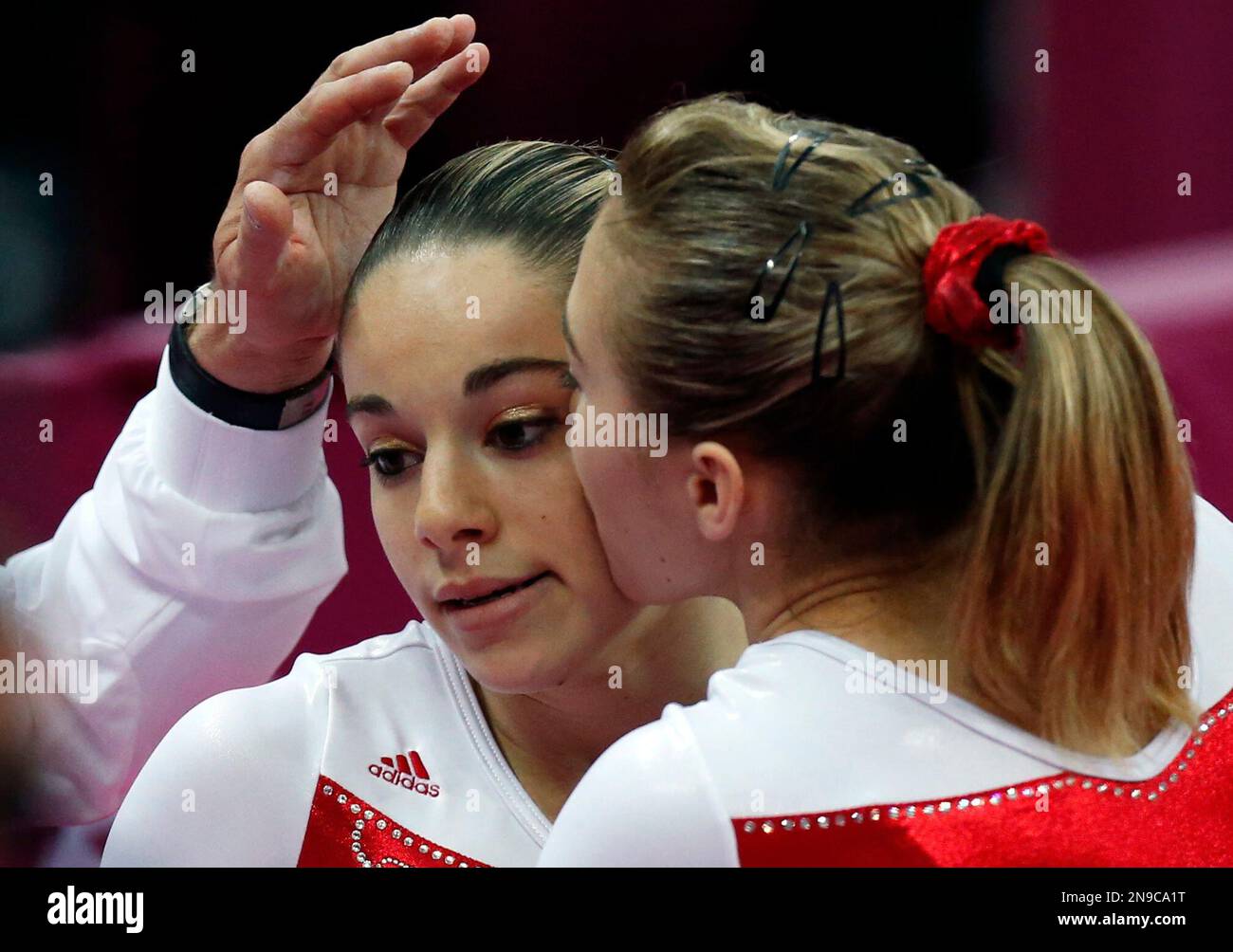 French gymnast Aurelie Malaussena kisses teammate Youna Dufournet ...