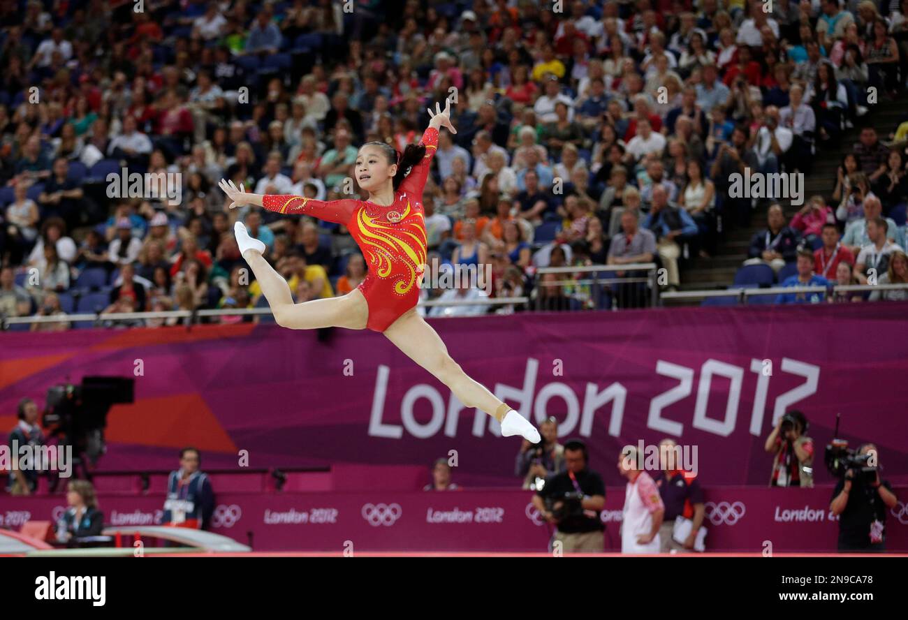 Spectators watch Chinese gymnast Deng Linlin perform during the ...