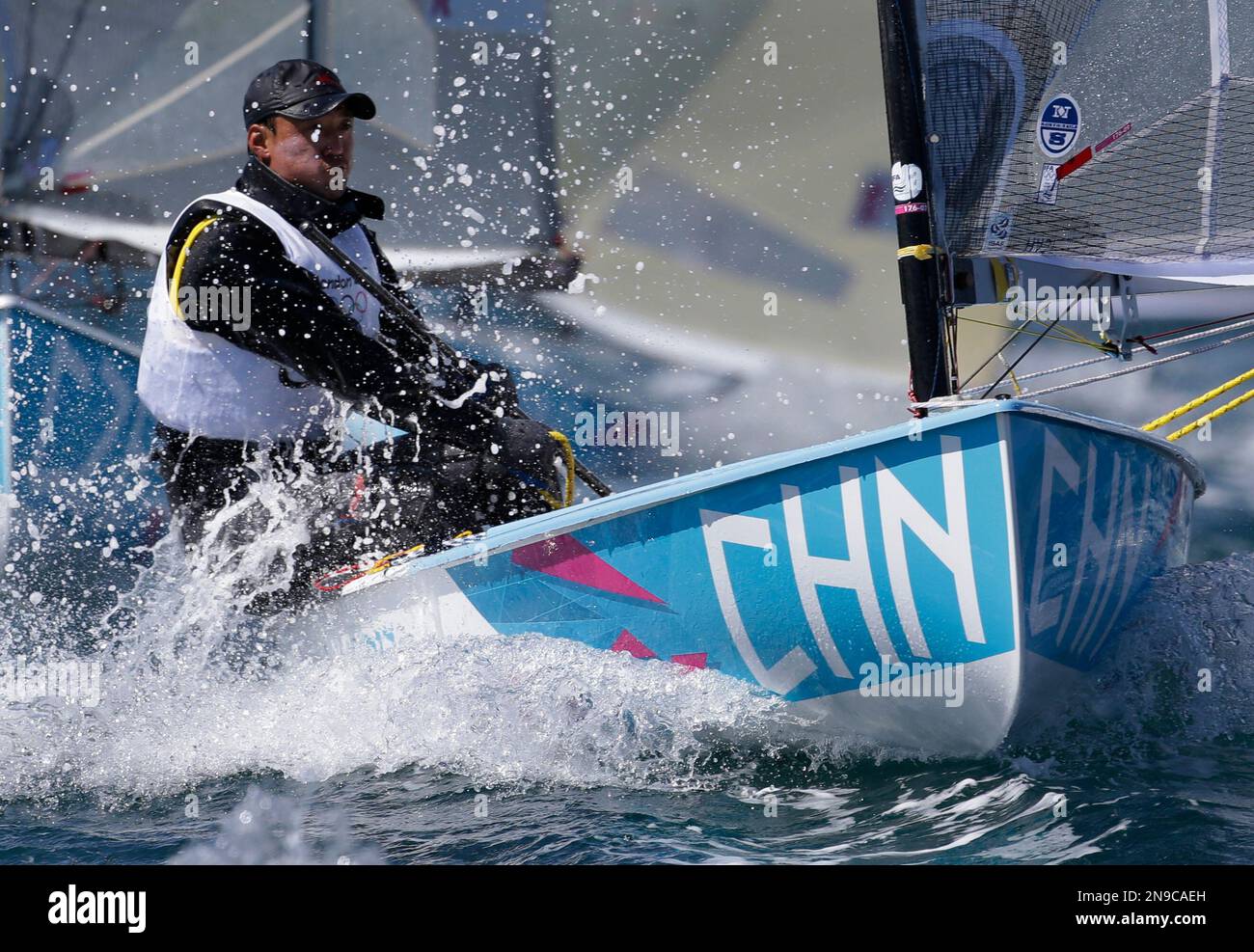 Gong Lei, from China, competes during the finn dinghy class race 2 at ...