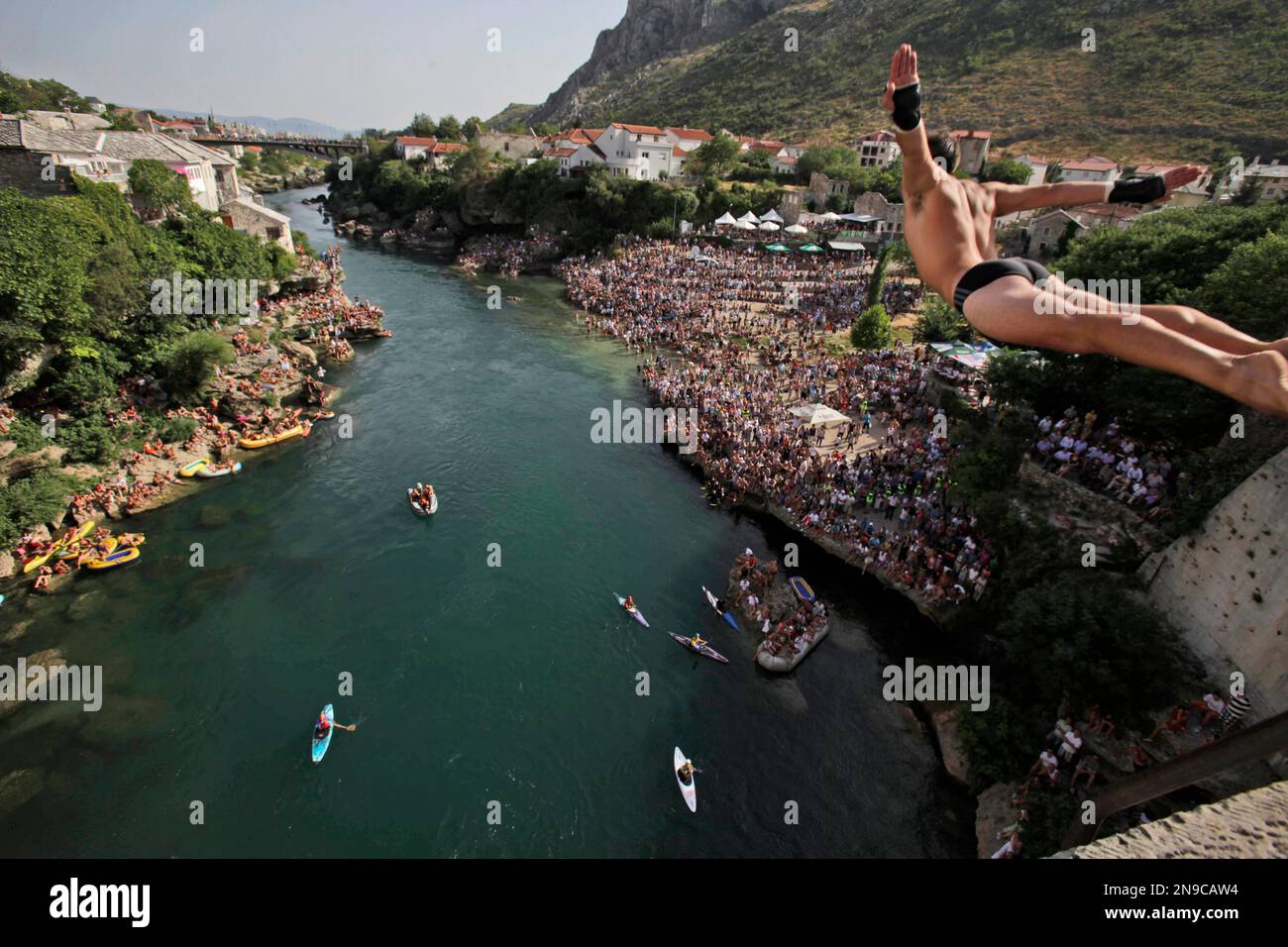 A diver drops from the Old Mostar Bridge, during 446th traditional ...