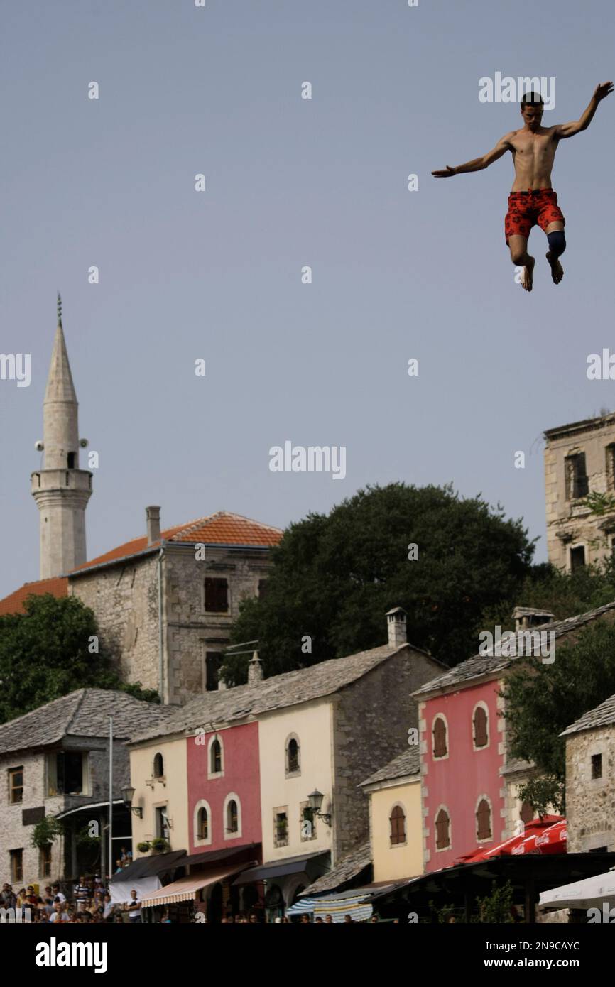 A diver drops from the Old Mostar Bridge, during 446th traditional ...