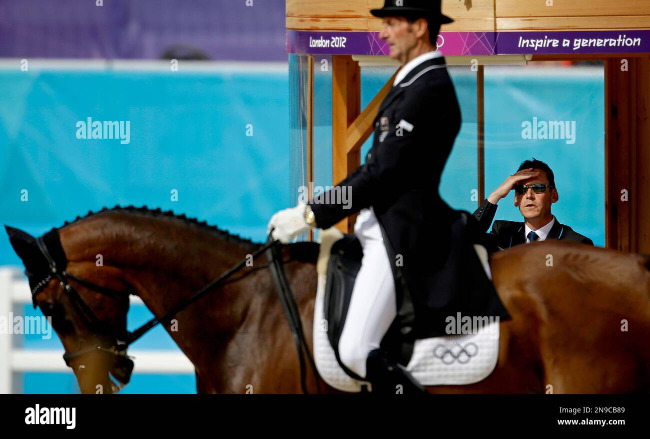 A judge at right looks on as Mark Todd of New Zealand, and his horse ...