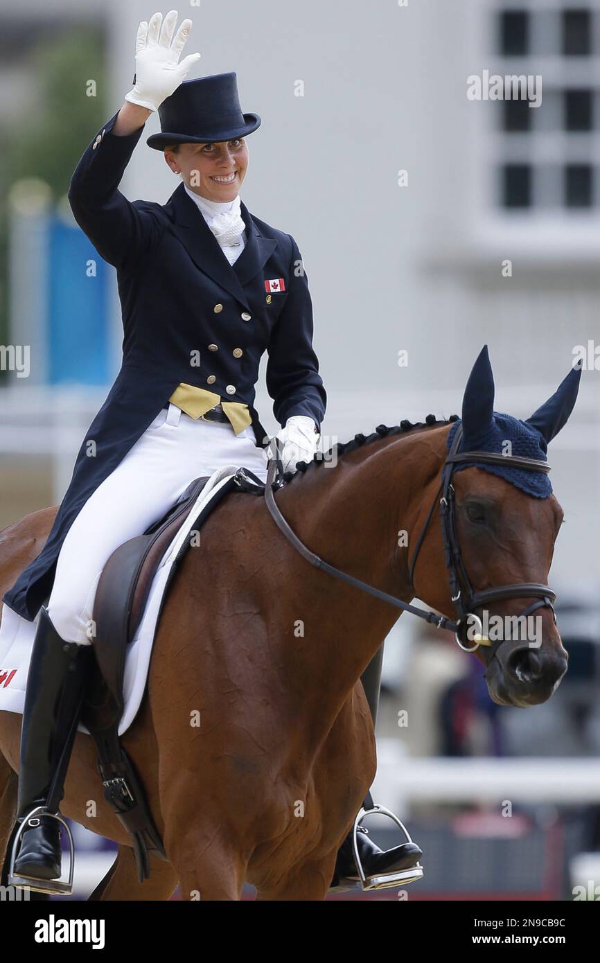 Rebecca Howard of Canada reacts after she competes with her horse ...