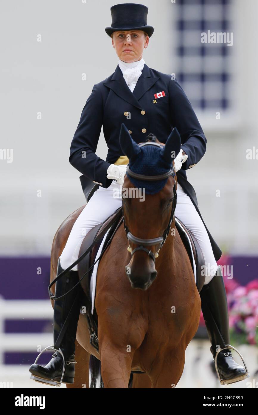 Rebecca Howard of Canada competes with her horse Riddle Master in the ...