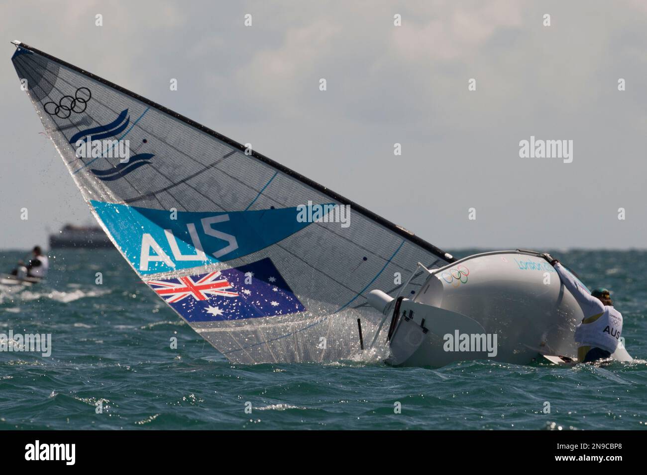 Australia's Brendan Casey capsizes his boat during the finn dinghy ...