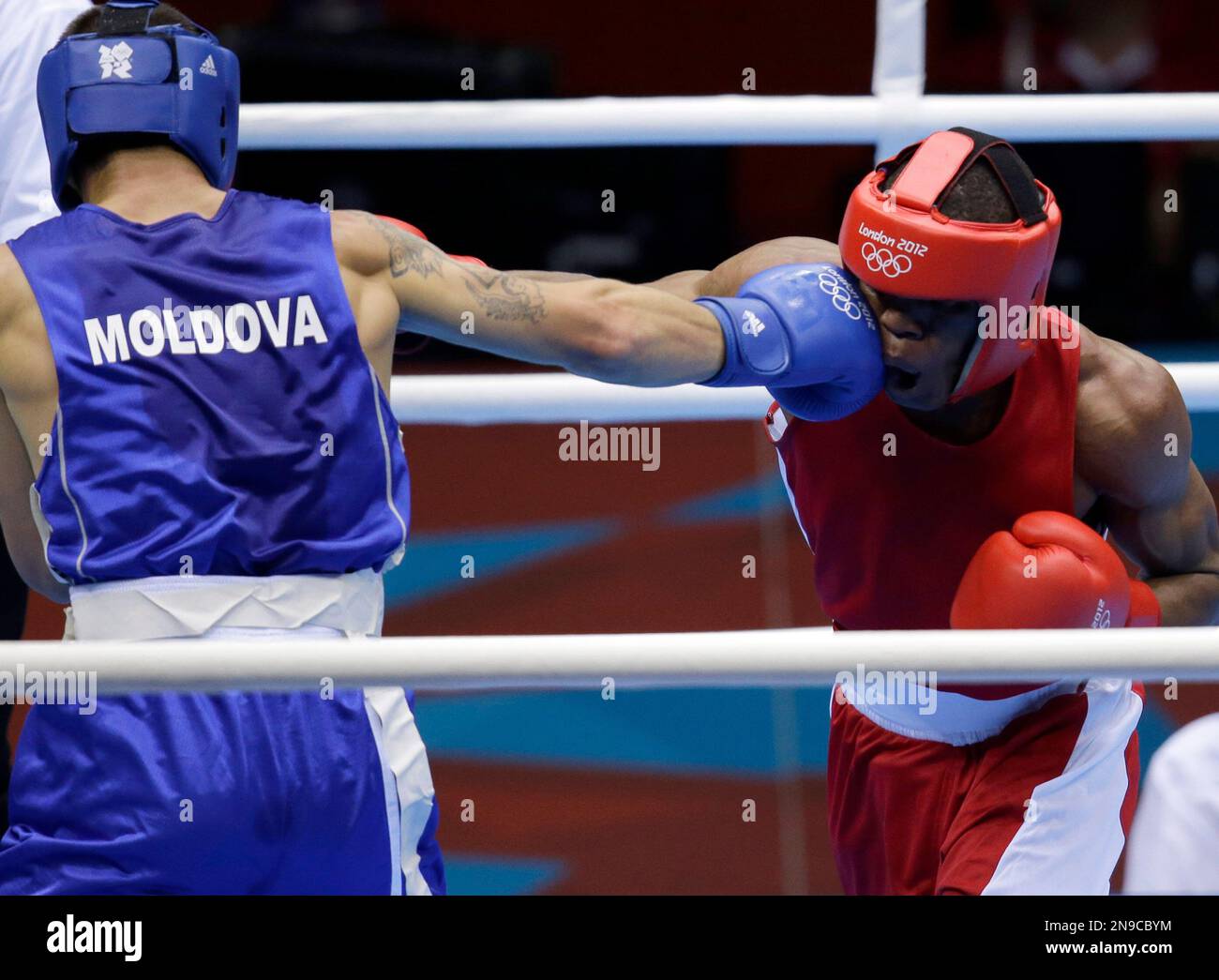 Moldova's Vasilii Belous, right, connects with Tanzania's Selemani ...