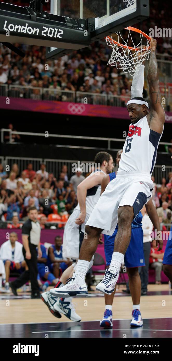 USA's Lebron James hangs on the rim following a dunk during the first ...