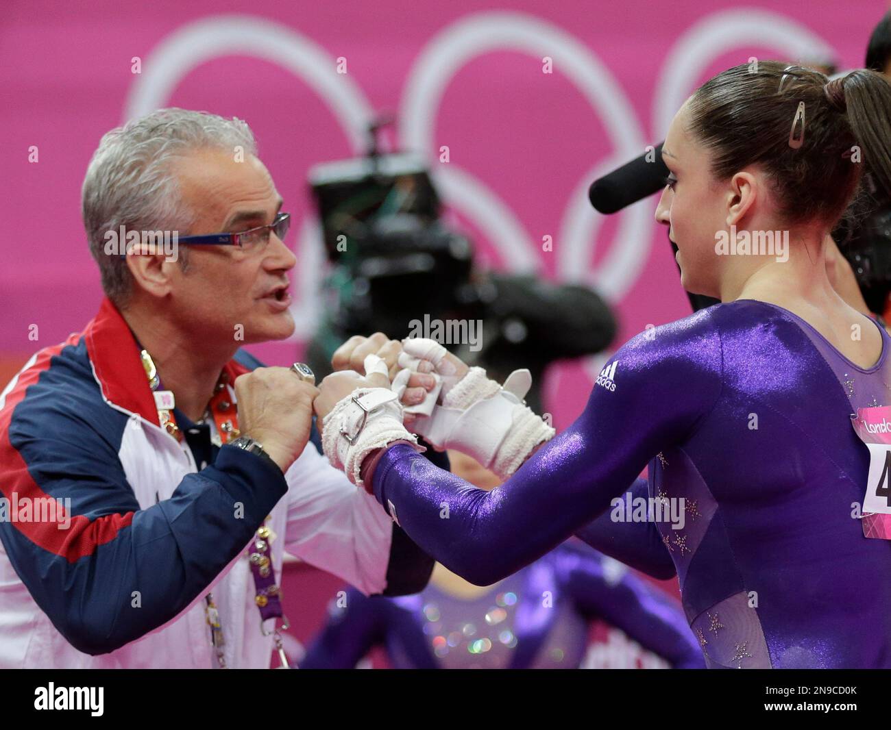 U.S. gymnast Jordyn Wieber, right, is greeted by head coach John ...