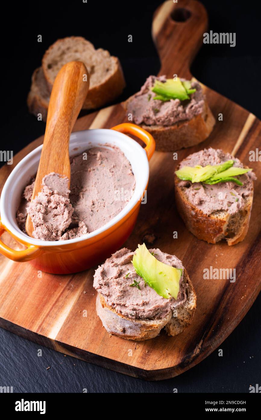 Food concept Chicken Liver spread Pate Baguette bite on wooden board on ...