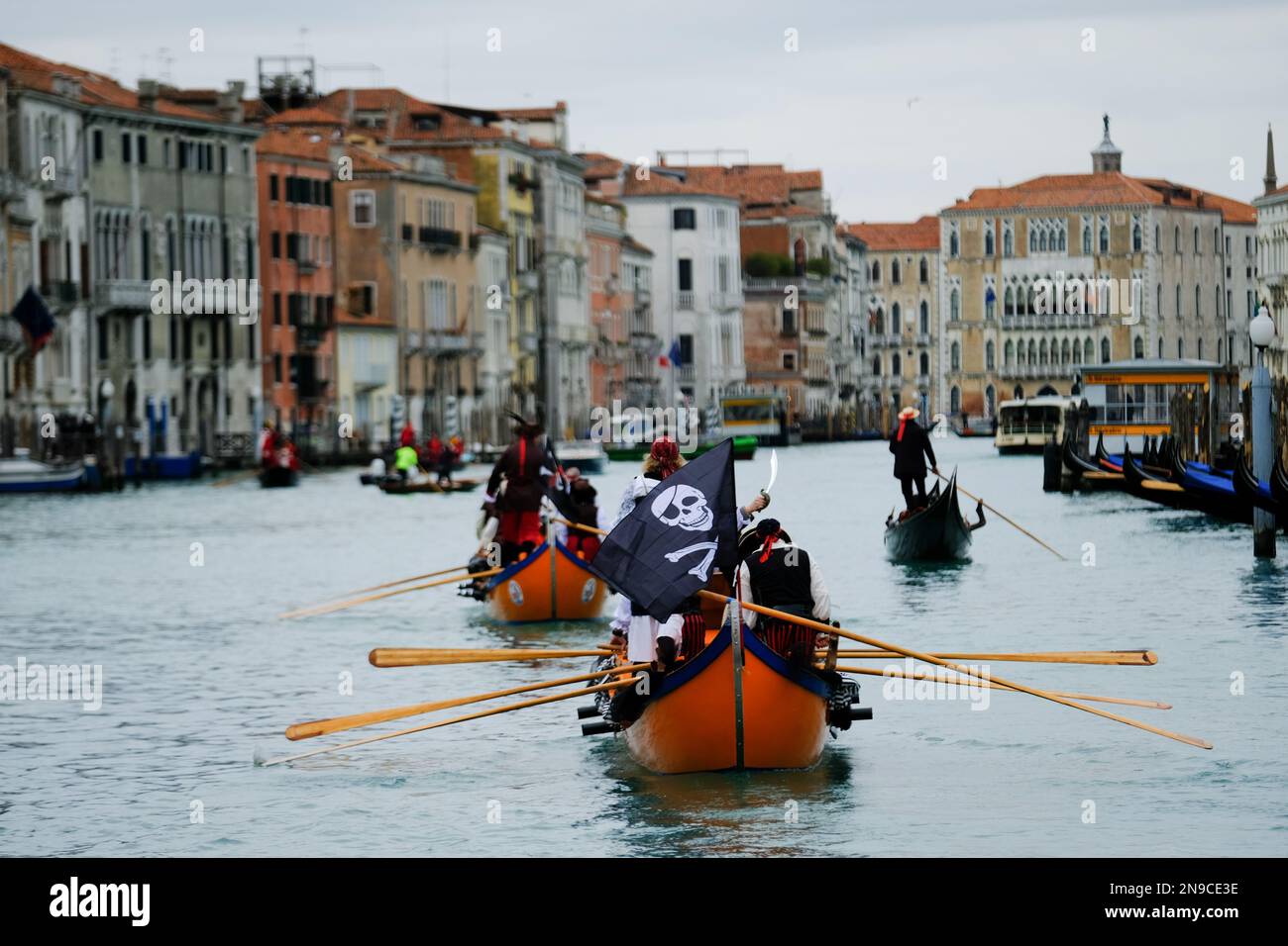Venetians take part in the masquerade parade on the Grand Canal during ...