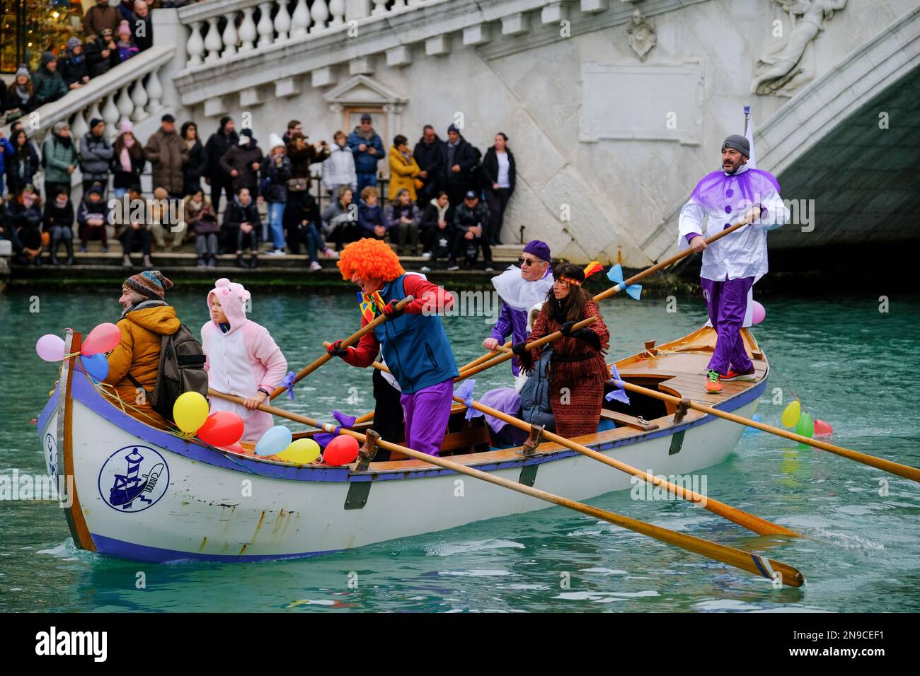 Venetians take part in the masquerade parade on the Grand Canal during ...