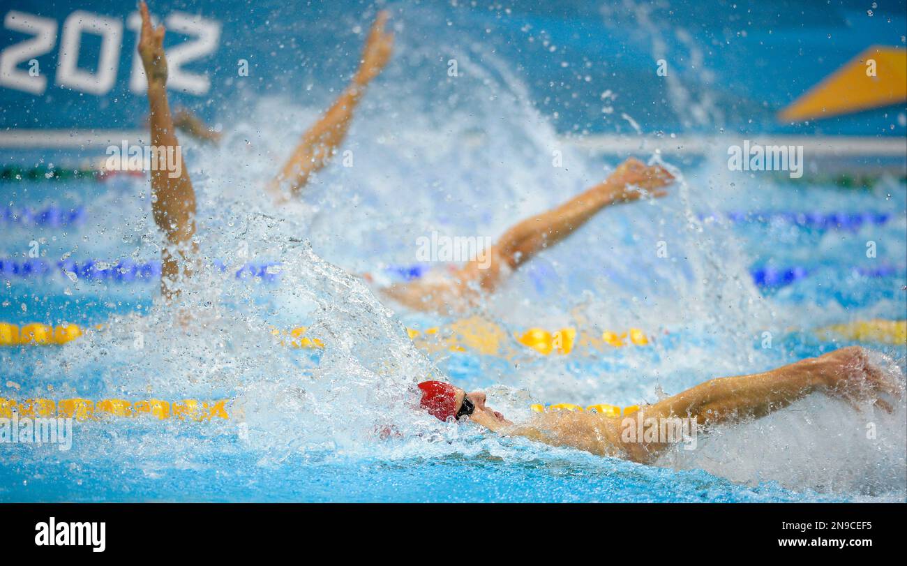 Britain's Liam Tancock, front, competes in a men's 100-meter backstroke ...