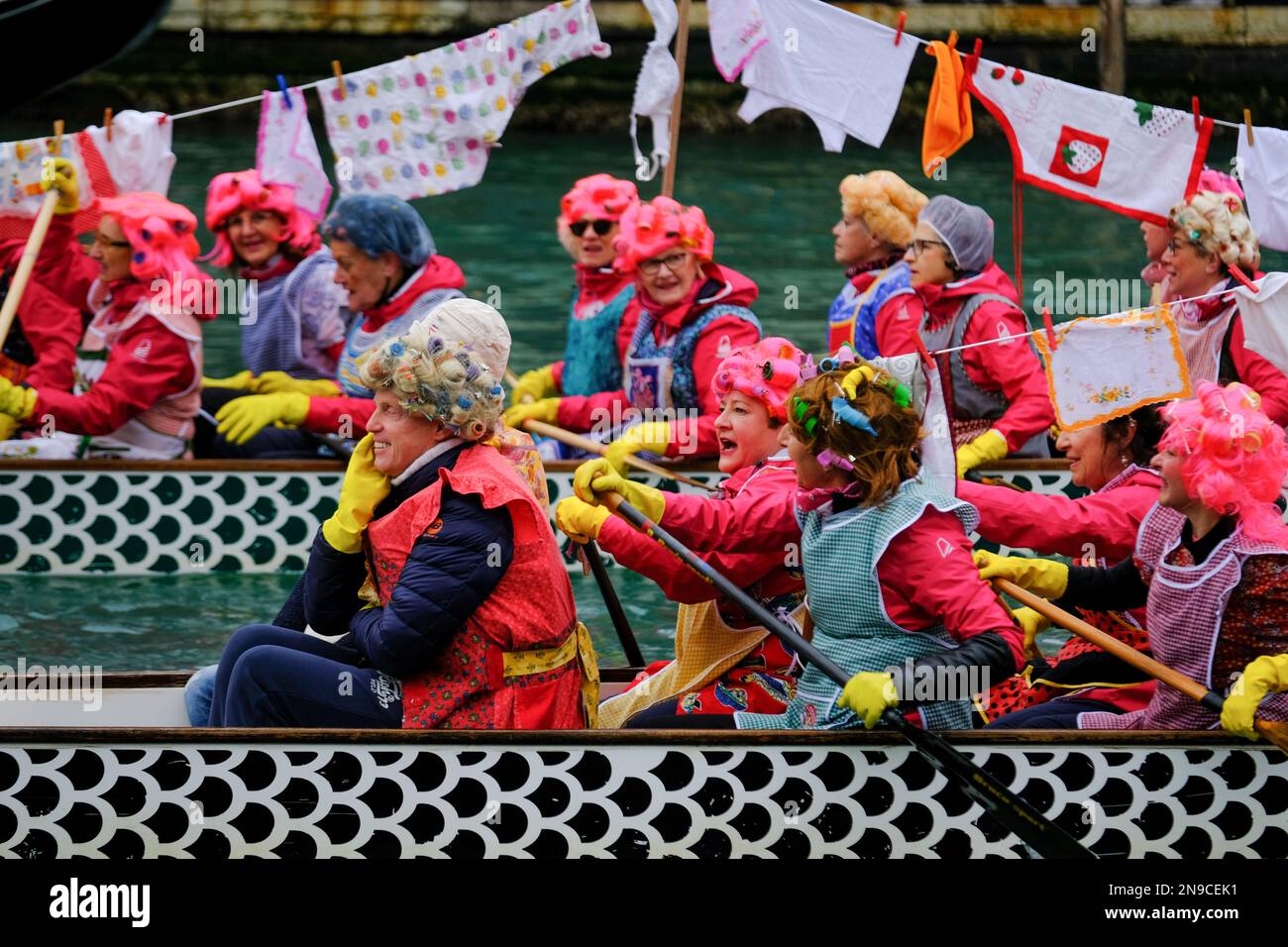 Venetians take part in the masquerade parade on the Grand Canal during ...