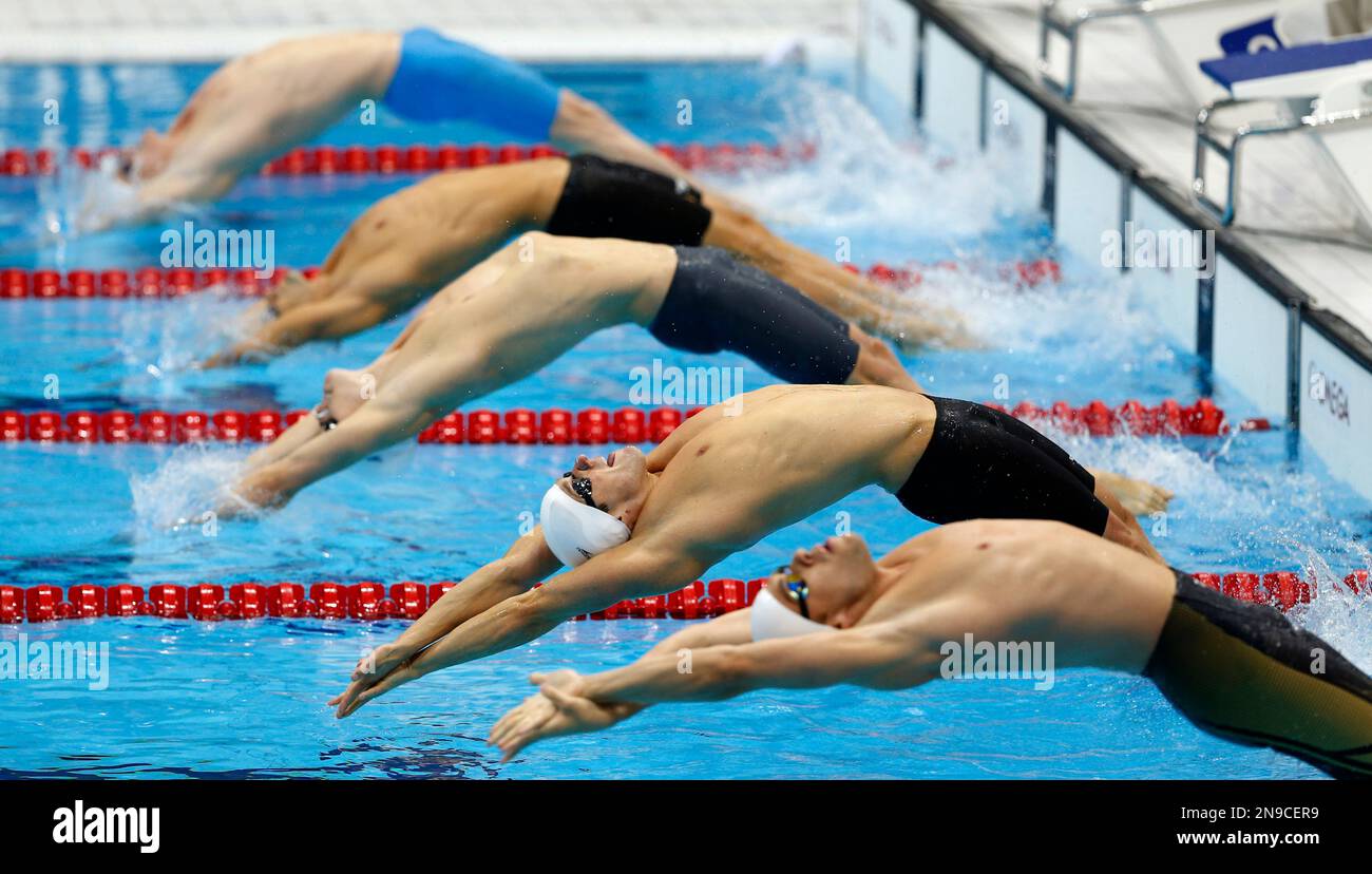 Swimmers start their heat in the men's 100-meter backstroke at the 2012 ...