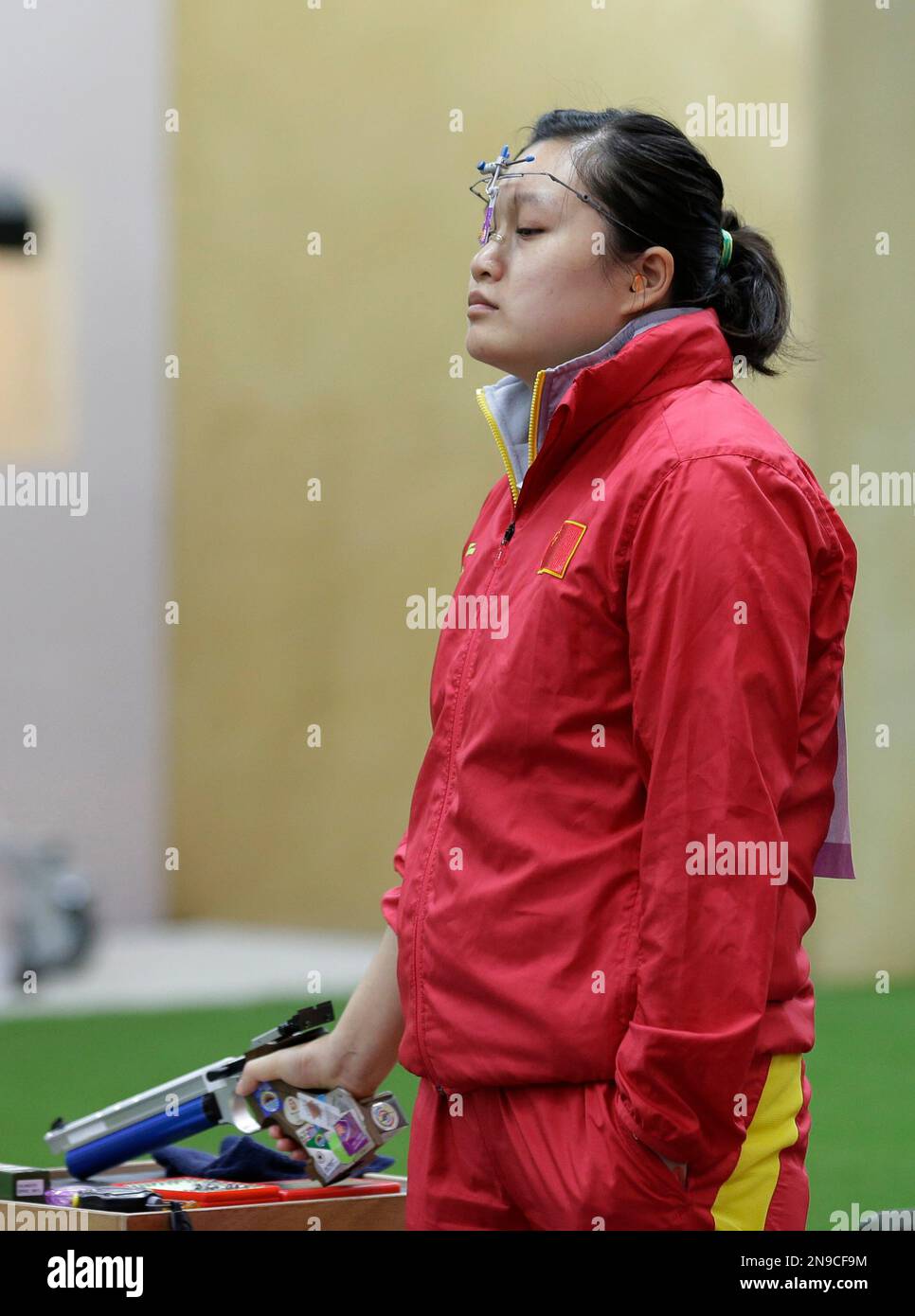 China's Guo Wenjun pauses between shots during qualifiers for the women ...