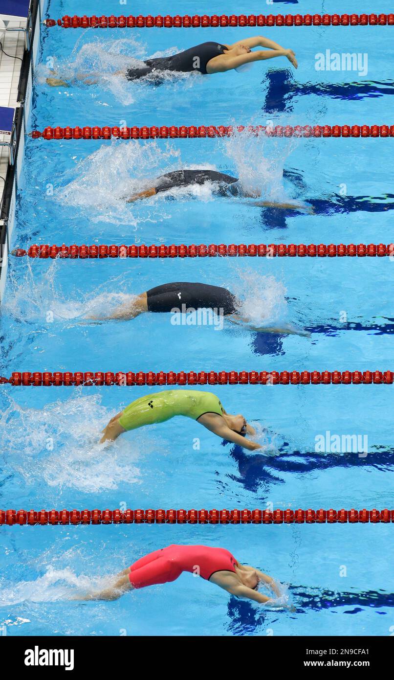 Swimmers start in the first heat of the women's 100-meter backstroke at ...