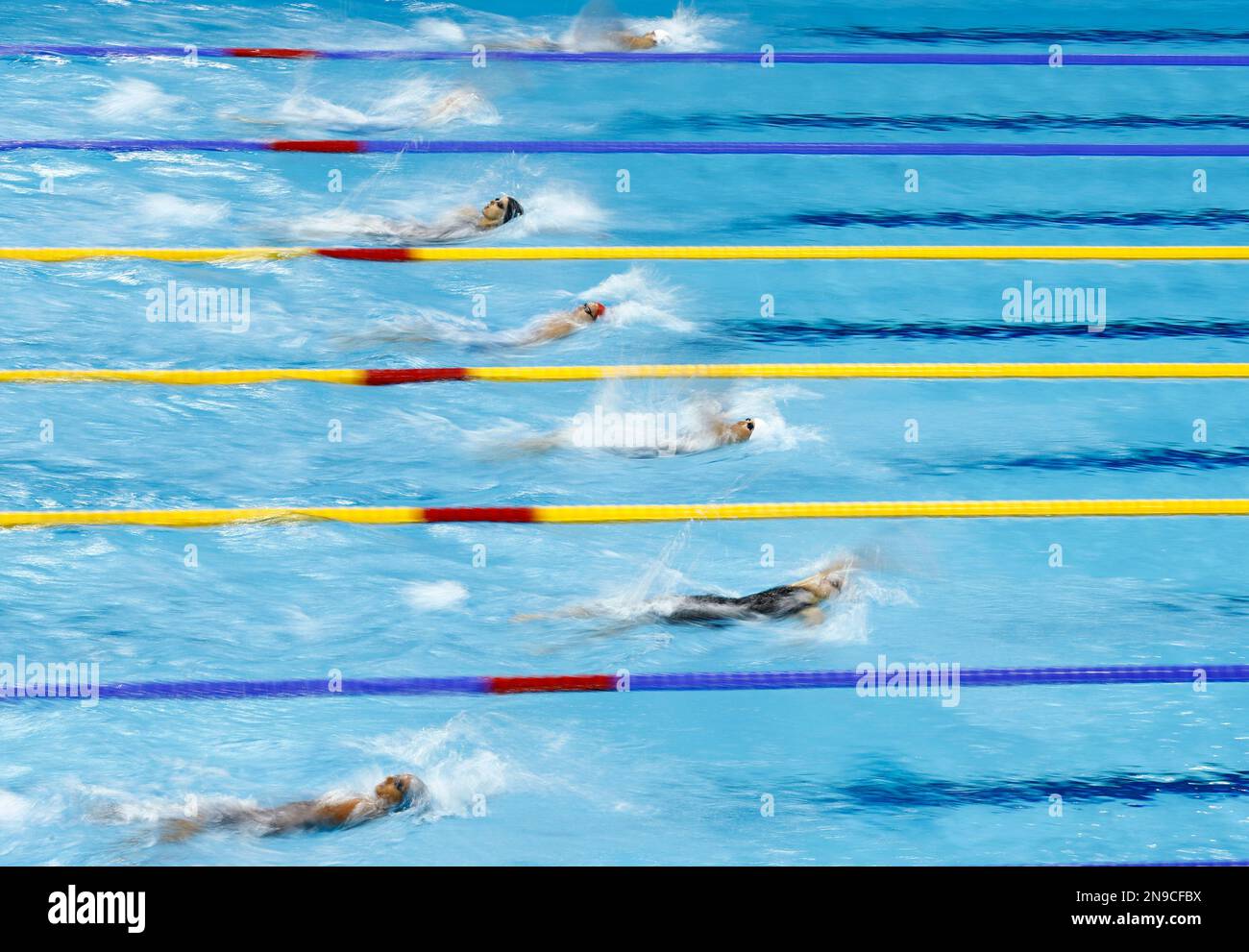 Swimmers compete in the first heat of the women's 100-meter backstroke ...