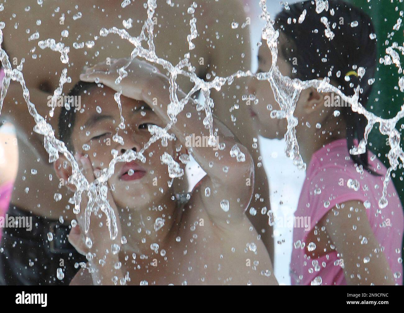 A Taiwanese boy gets a splash of water at Taipei Water Museum in Taipei ...