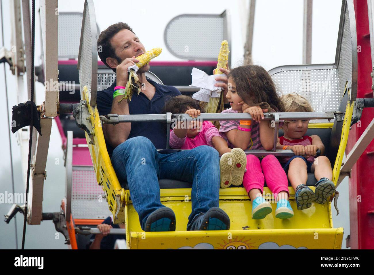Mark Feuerstein rides a ferris wheel with his children, from left to ...