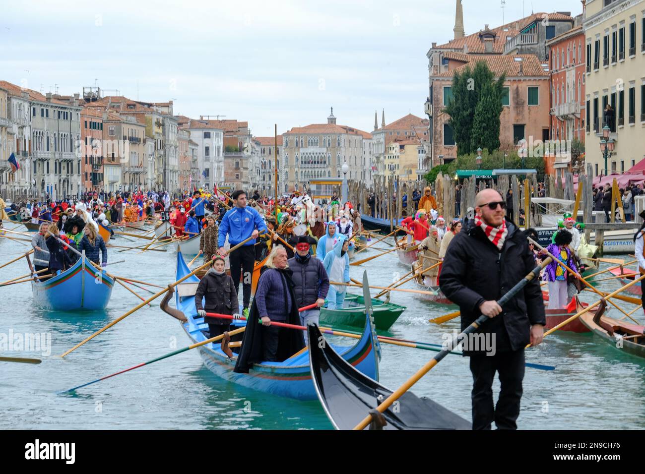 Venetians take part in the masquerade parade on the Grand Canal during ...