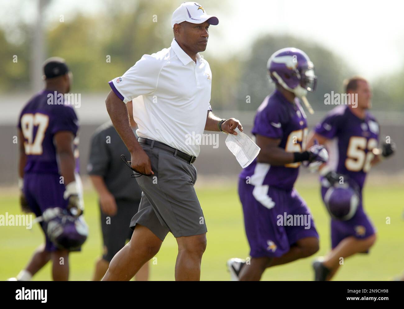 Minnesota Vikings head coach Leslie Frazier runs down the field with ...
