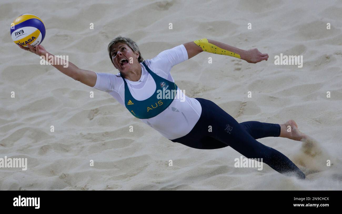 Australia's Natalie Cook dives for the ball during a beach volleyball ...