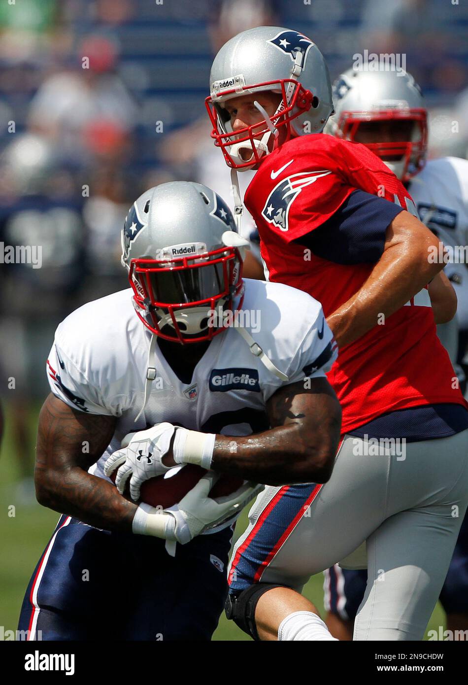New England Patriots' Stevan Ridley, left, runs with the ball after a ...