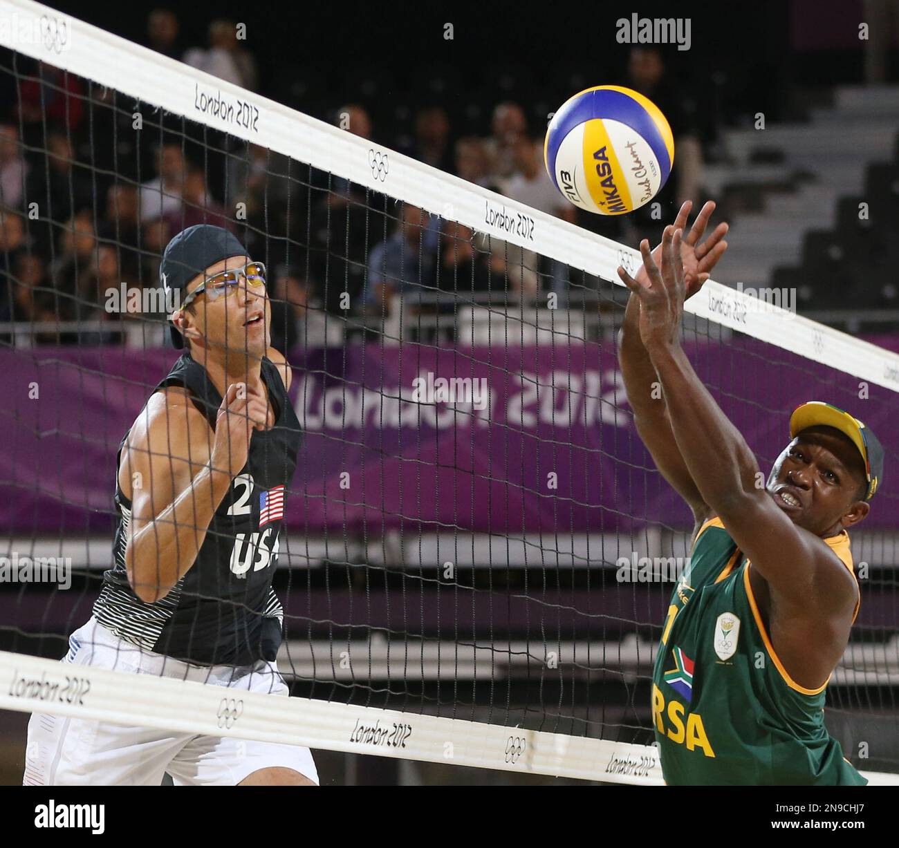 Sean Rosenthal, left, of US spikes a ball past Freedom Chiya, right ...