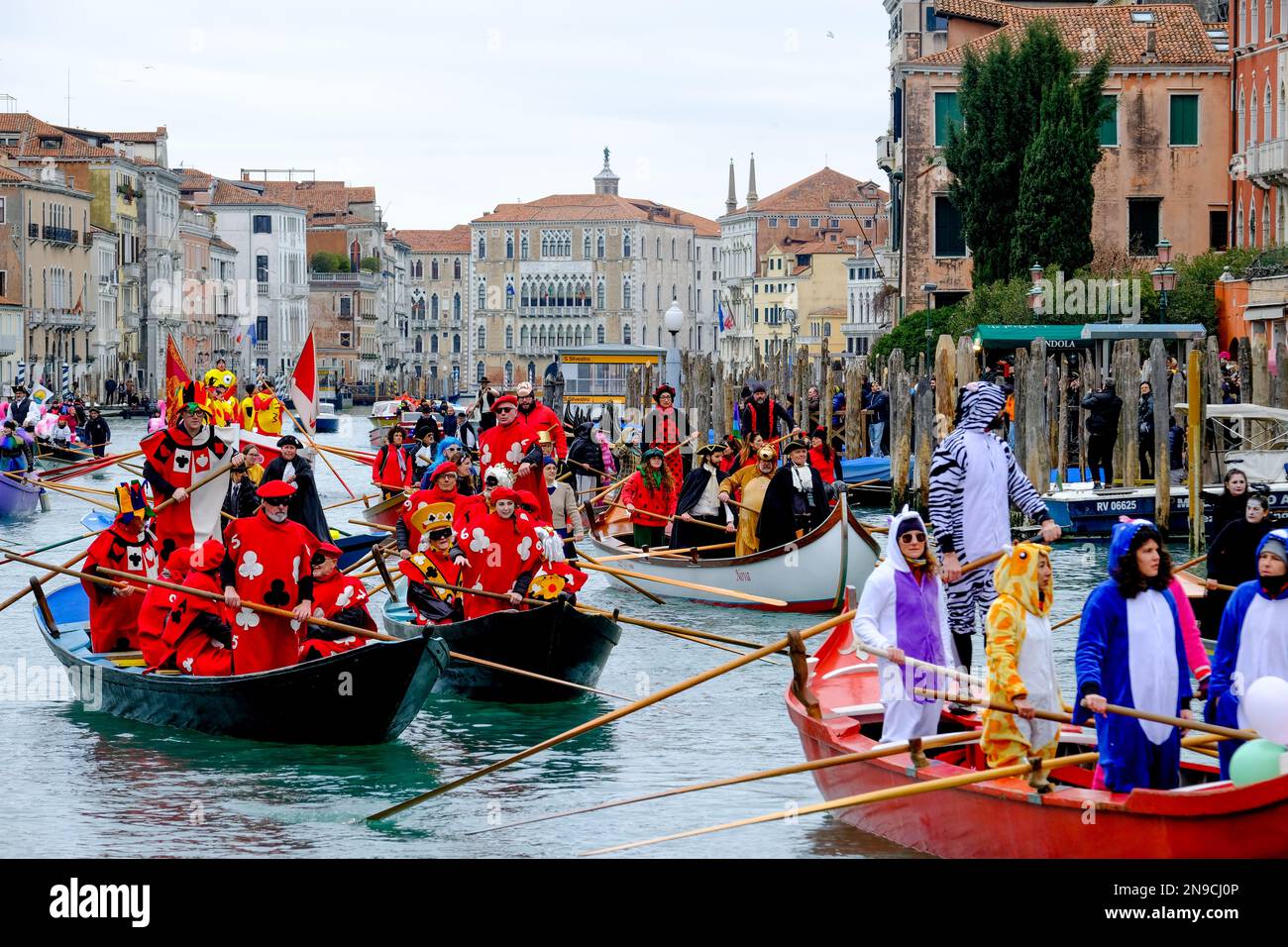 Venetians take part in the masquerade parade on the Grand Canal during ...