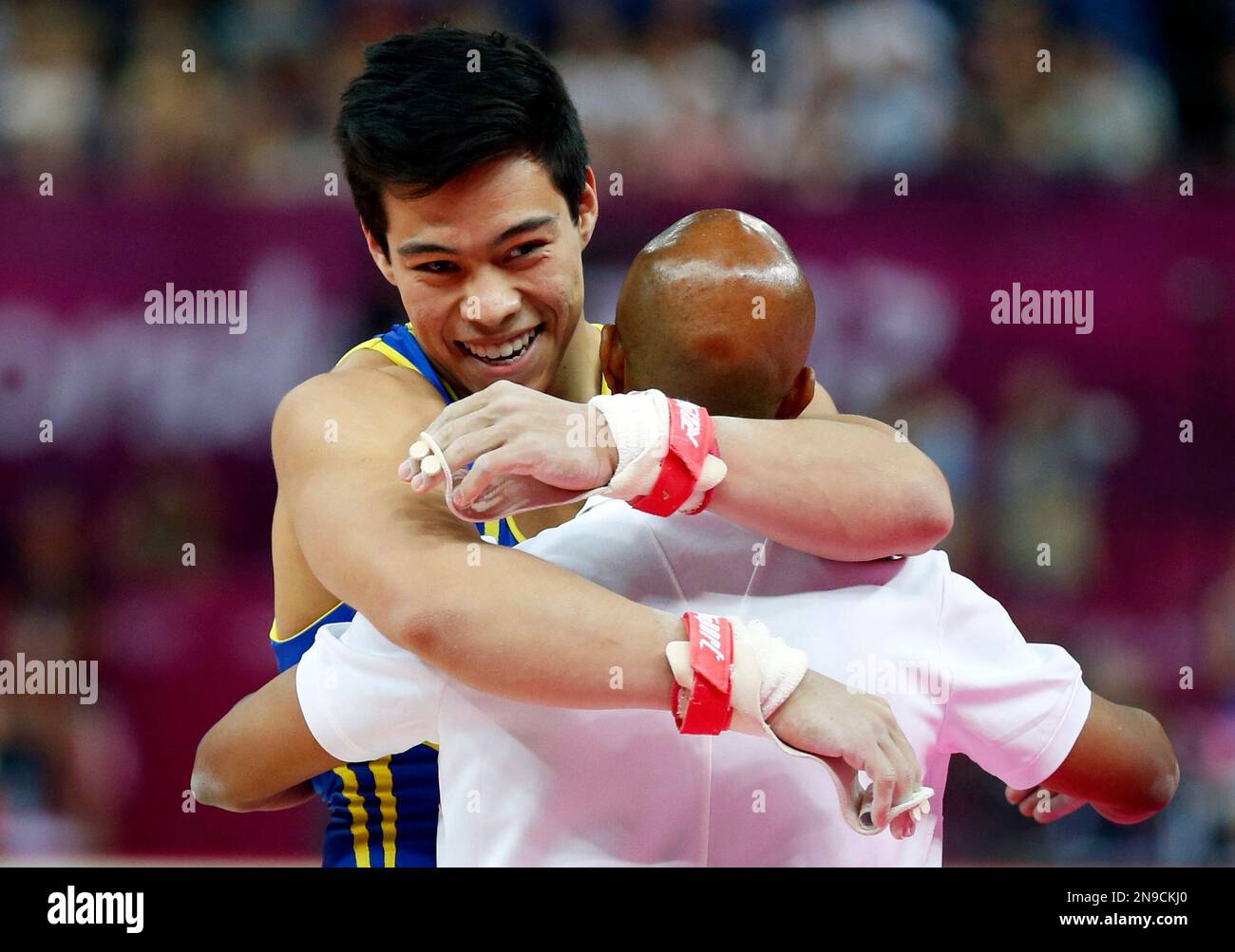 Brazilian gymnast Sergio Sasaki Junior hugs his coach Marcos Goto after ...