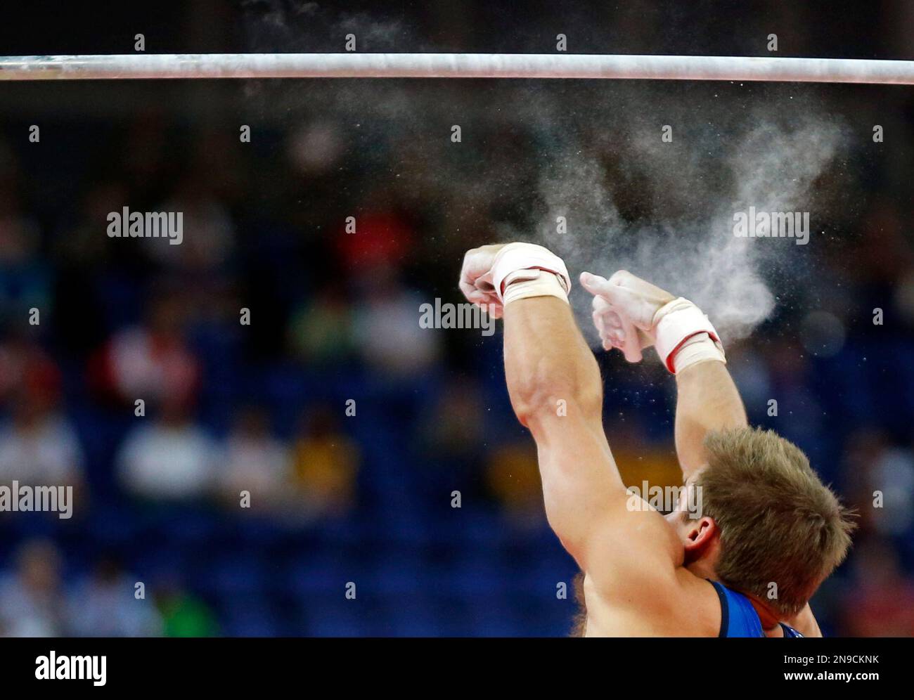 U.S. gymnast Samuel Mikulak chalks the horizontal bar before a ...